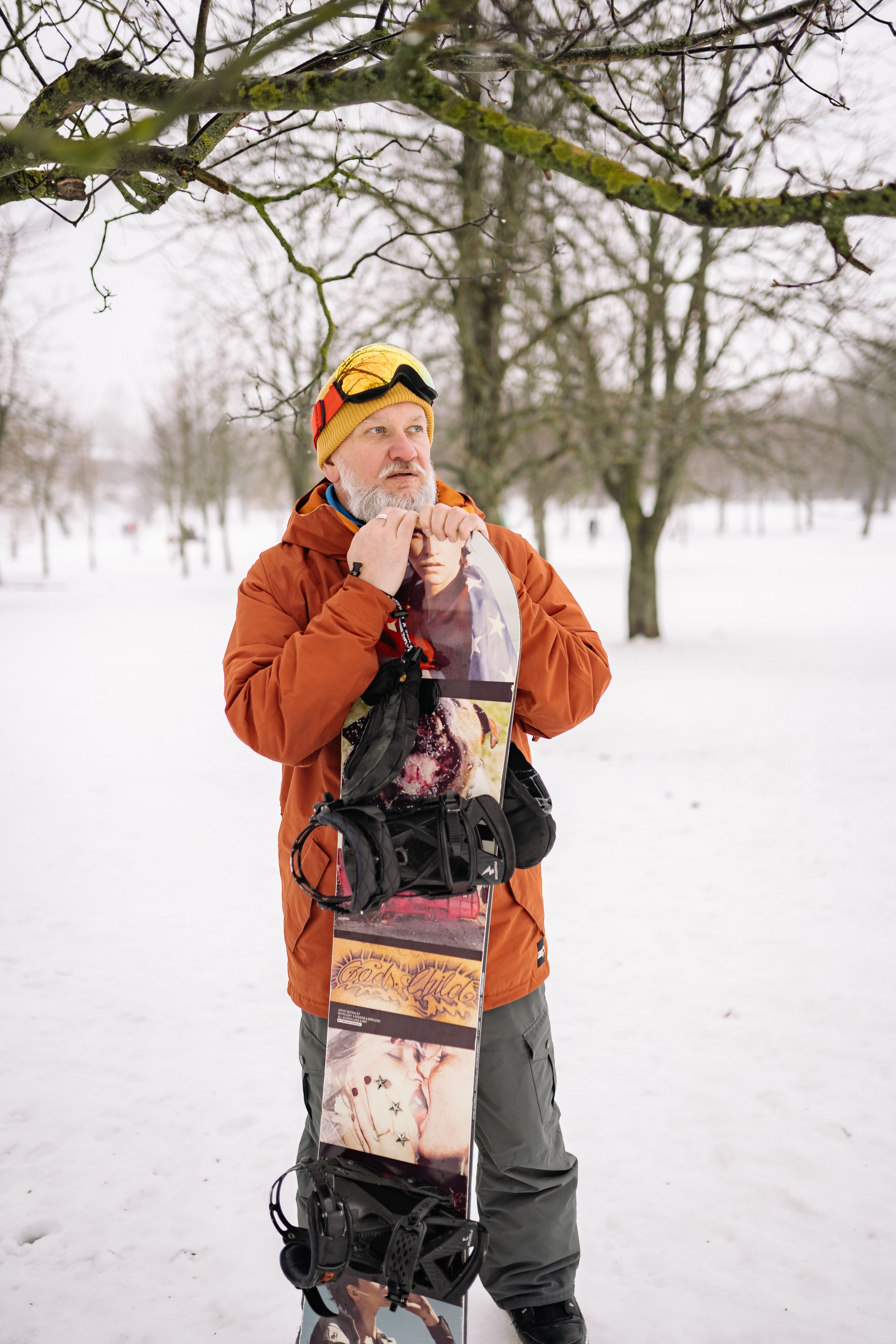 An Elderly Man Holding a Snowboard · Free Stock Photo