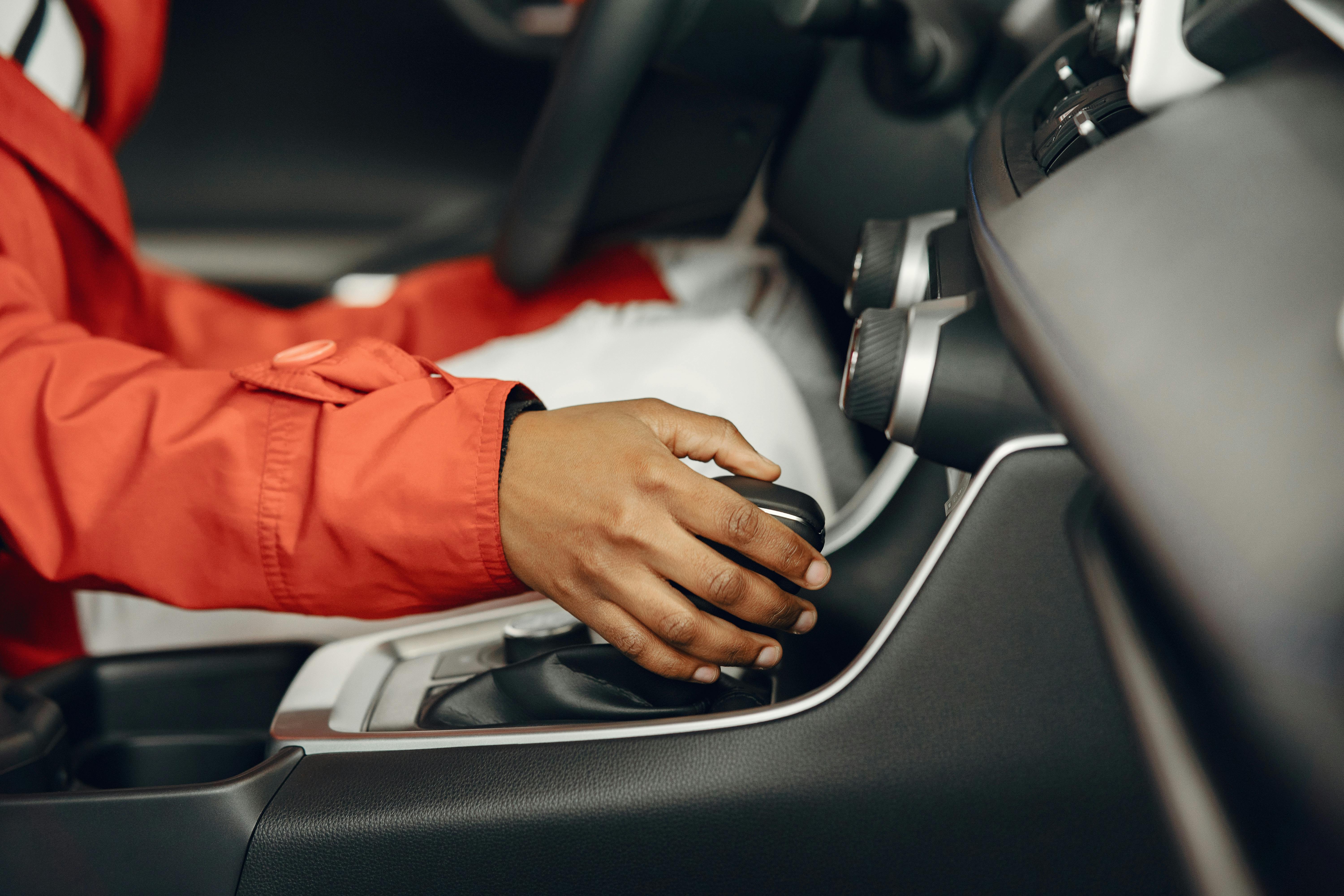 Hand of a Person Operating the Gearshift While Driving · Free Stock Photo
