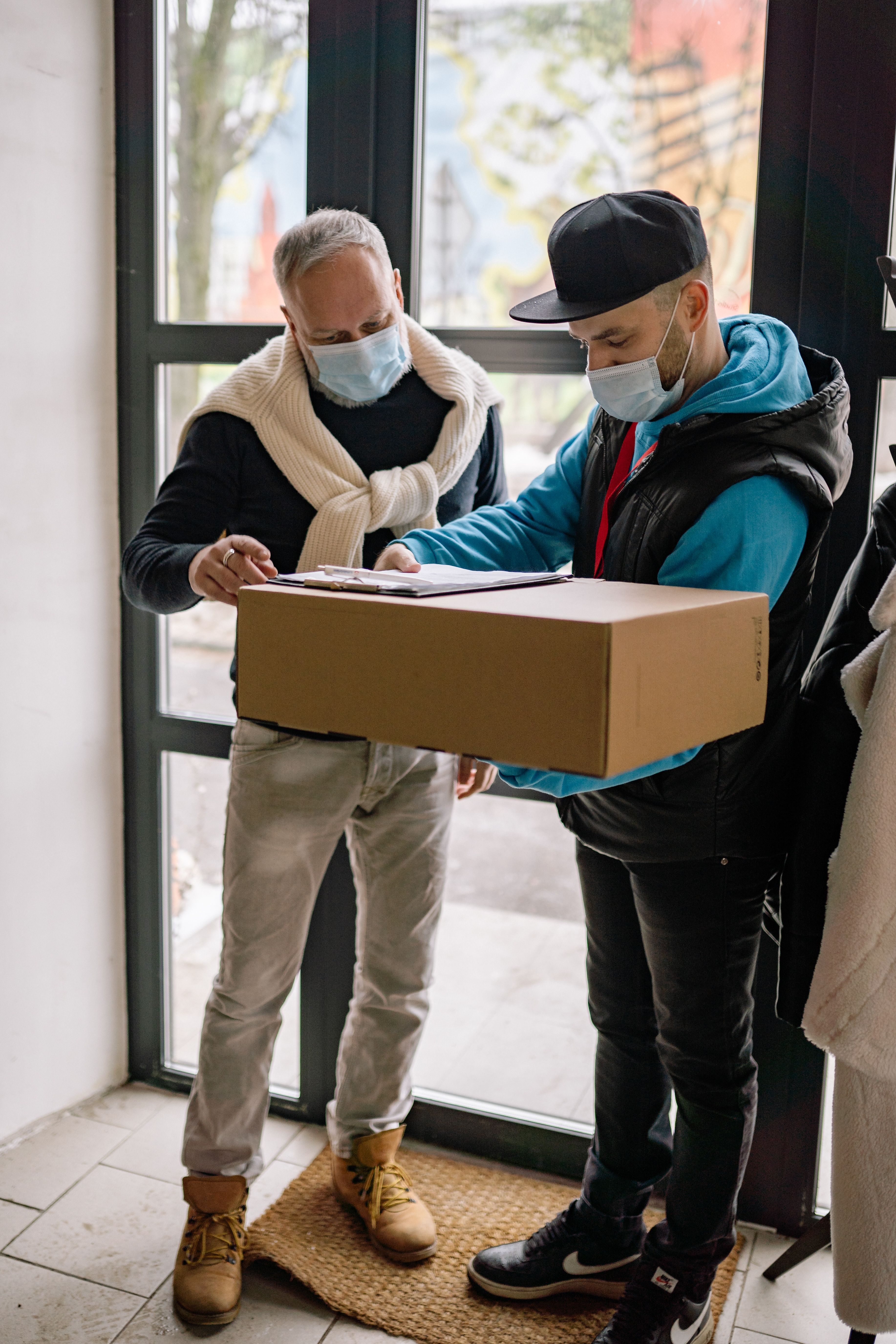 Customer Signing a Delivery Document · Free Stock Photo