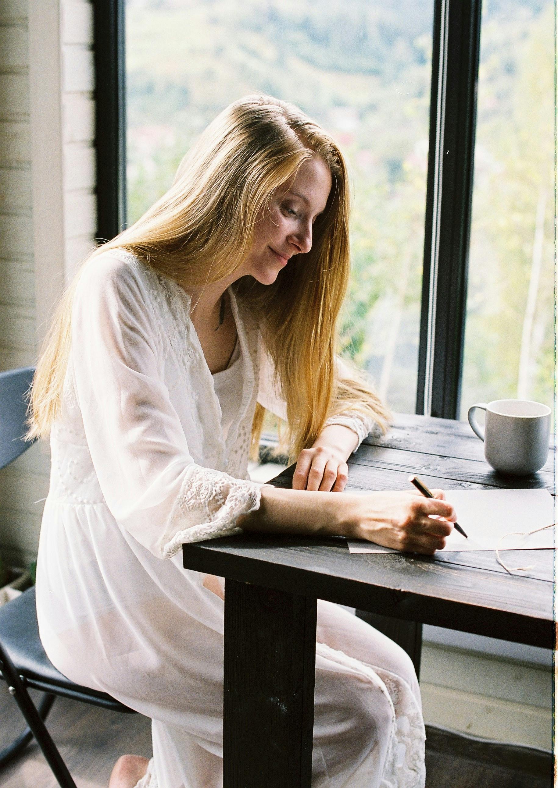Woman in White Silk Robe Writing · Free Stock Photo