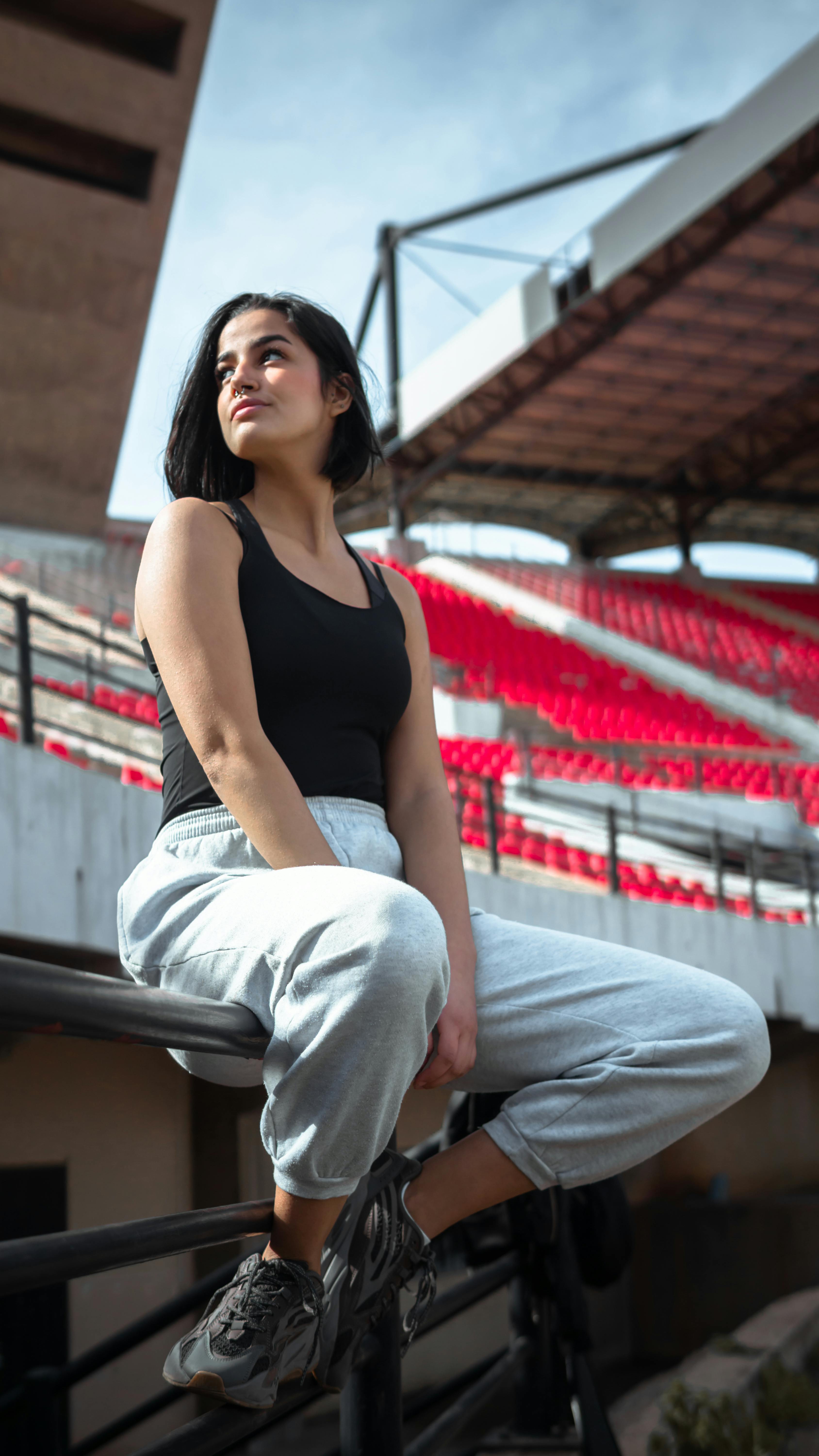 A Woman Posing by the Railing Beside the Plants · Free Stock Photo