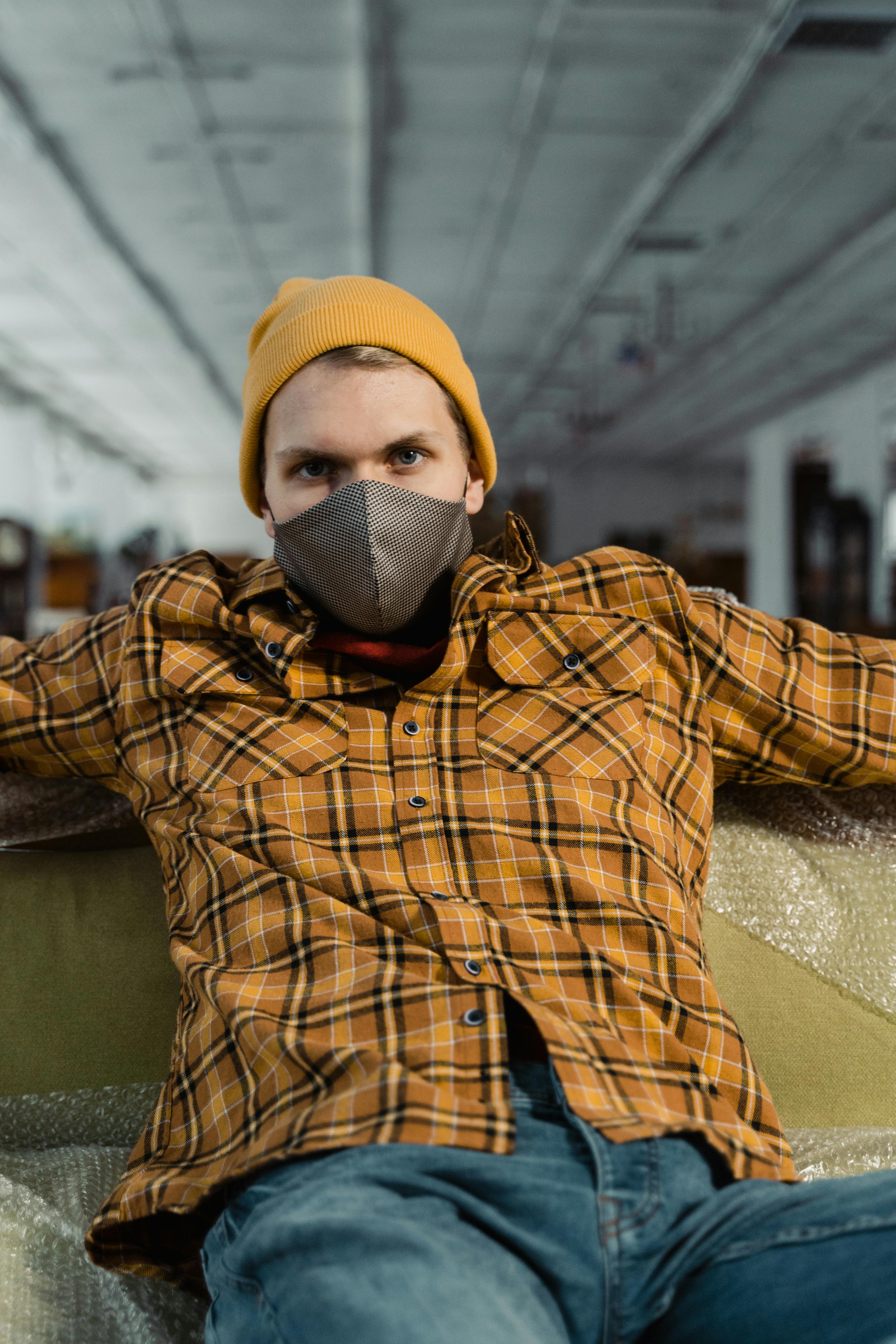 Man in Beanie Sitting on Treshold · Free Stock Photo