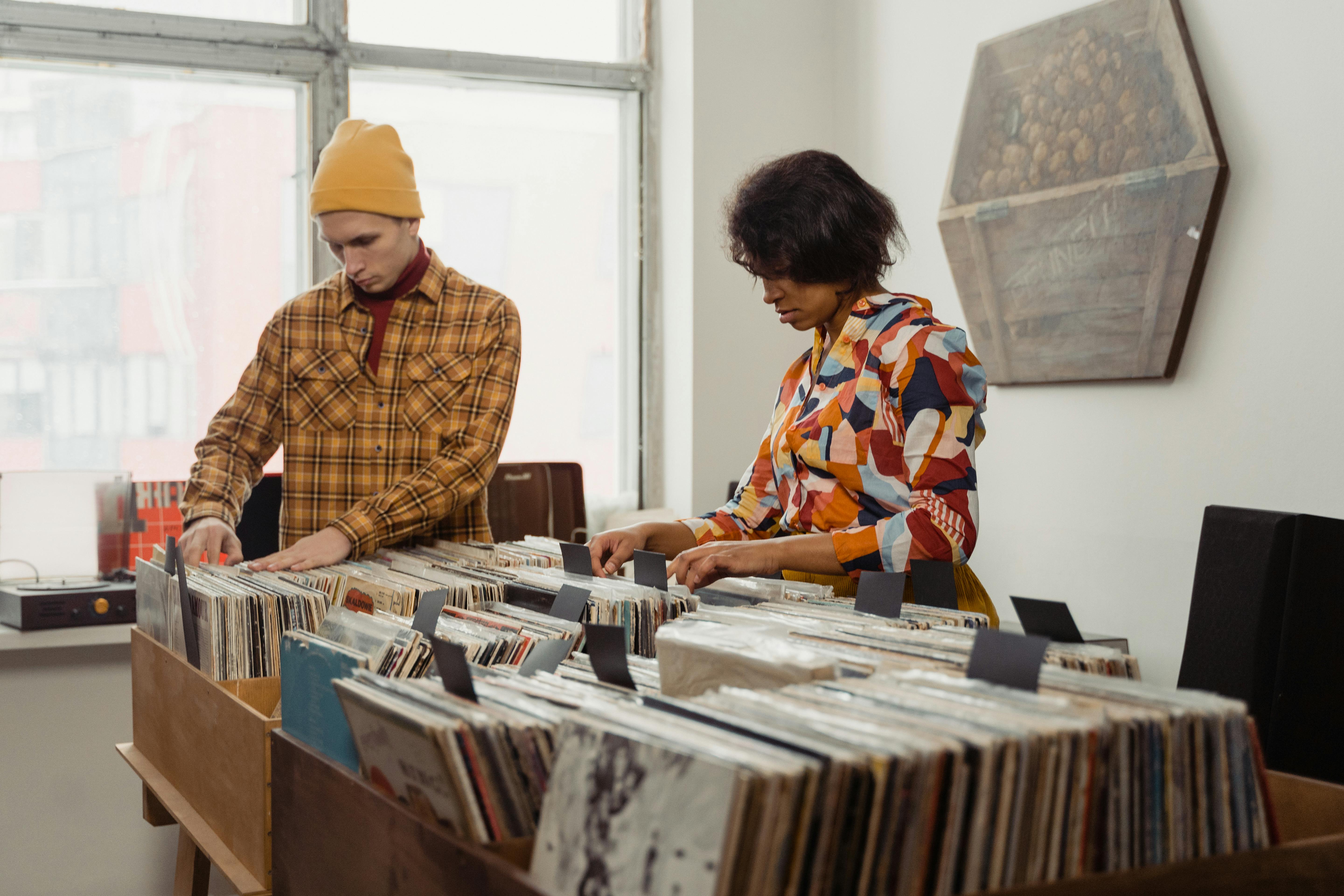 Man and Woman Looking at Vinyl Records · Free Stock Photo