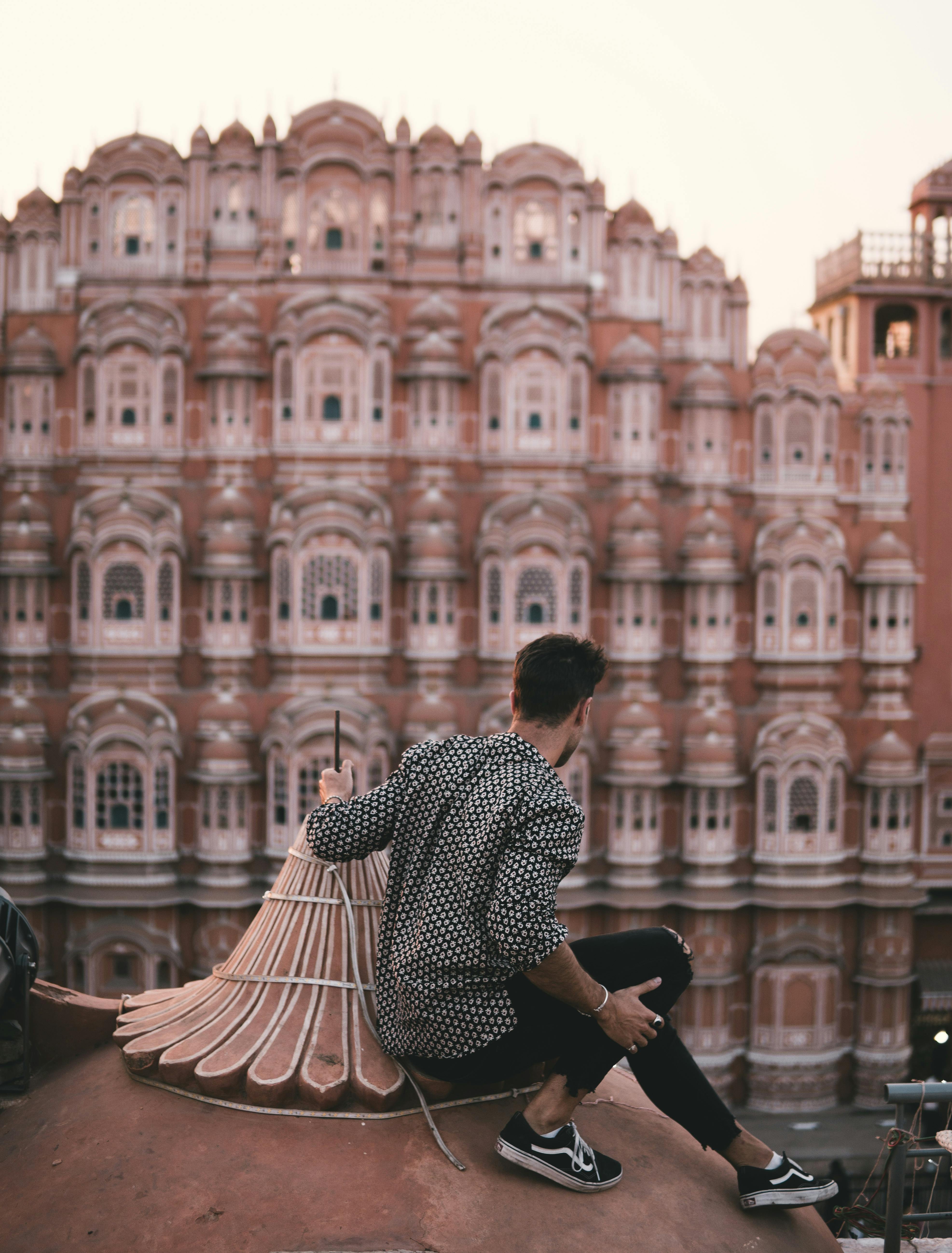 Man Sitting on Roof in City · Free Stock Photo