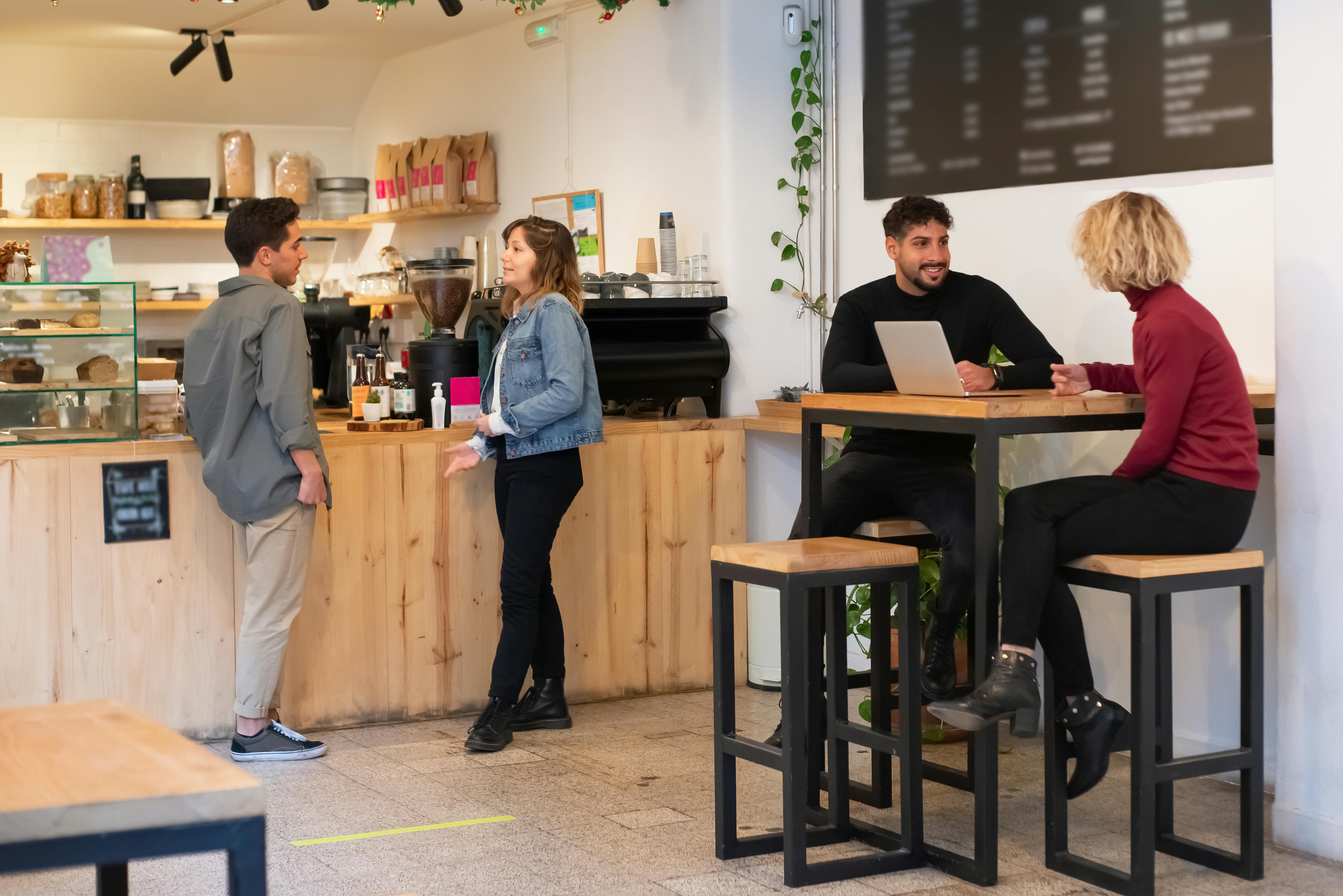 People Having a Conversation in a Coffee Shop · Free Stock Photo