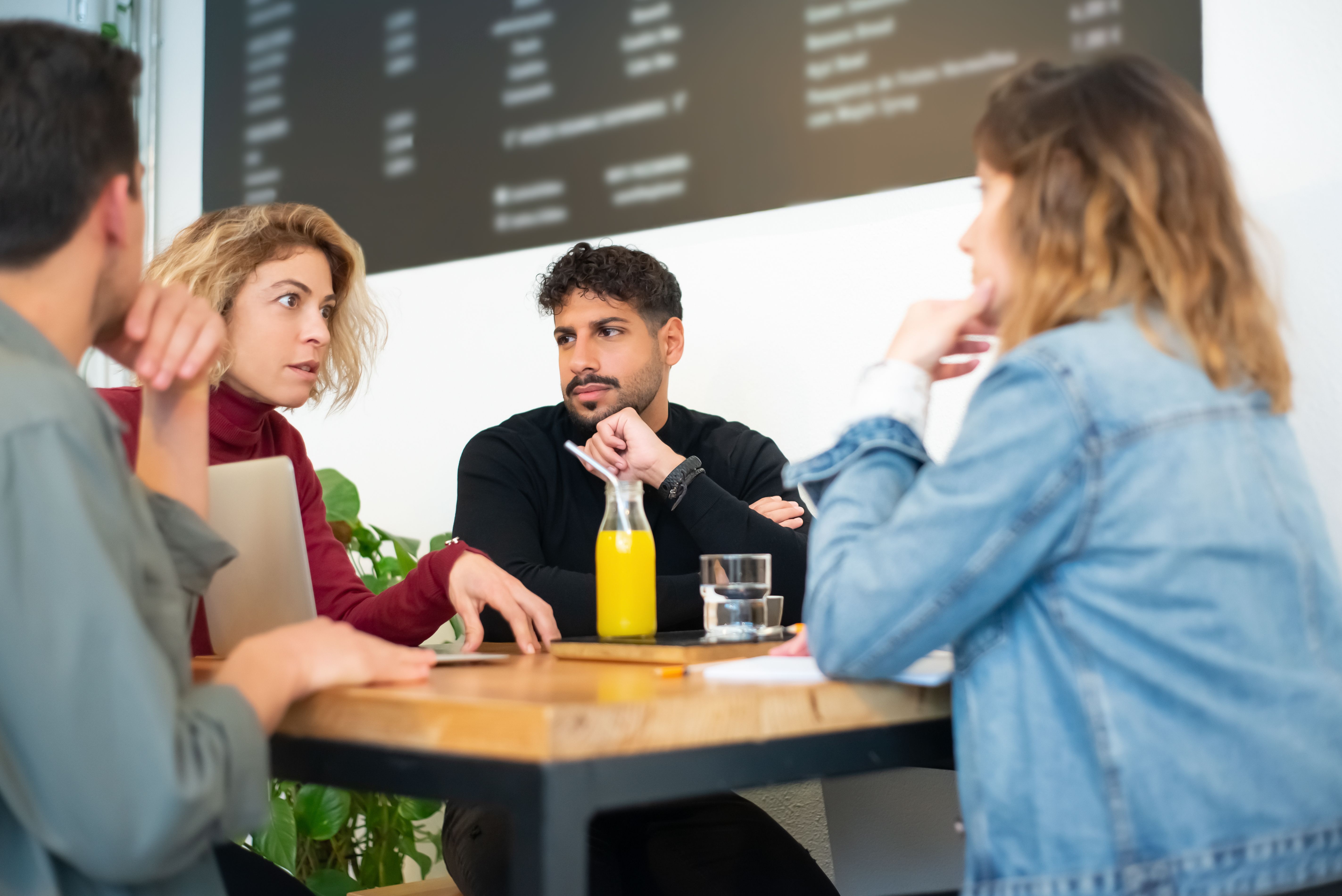 People Having a Conversation in a Cafe · Free Stock Photo