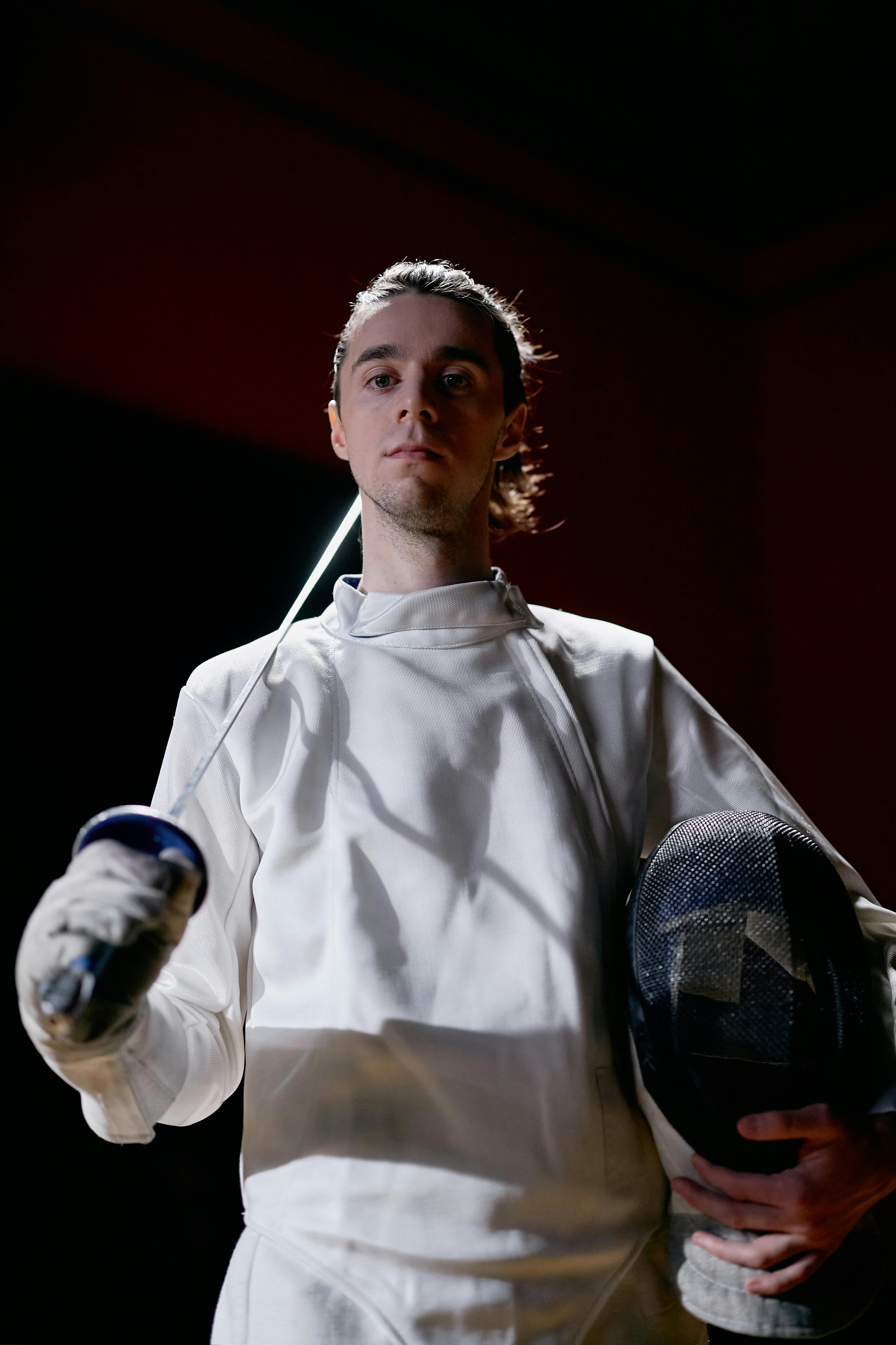 A Man Holding his Fencing Mask · Free Stock Photo