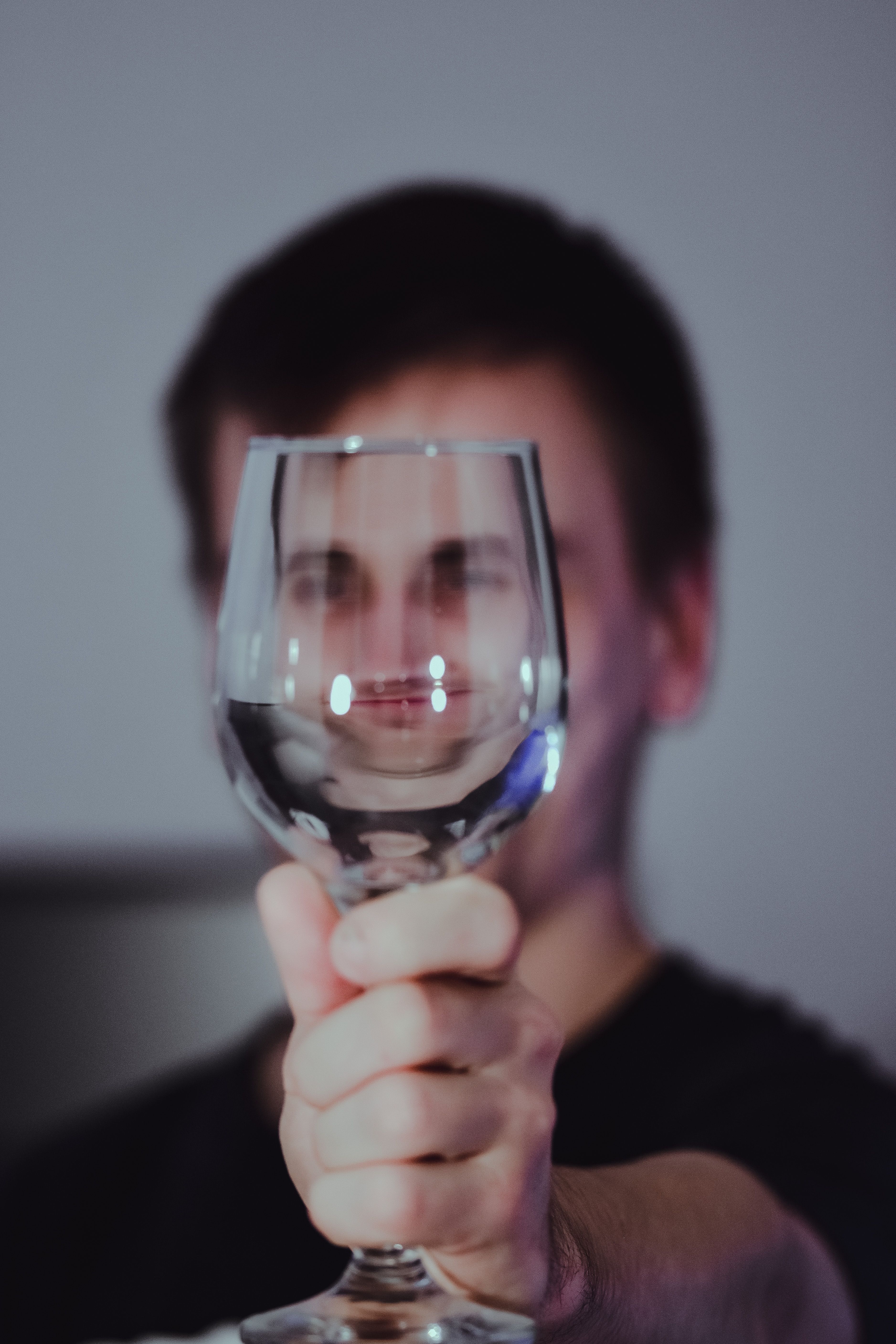 Young man looming at camera through transparent glass · Free Stock Photo