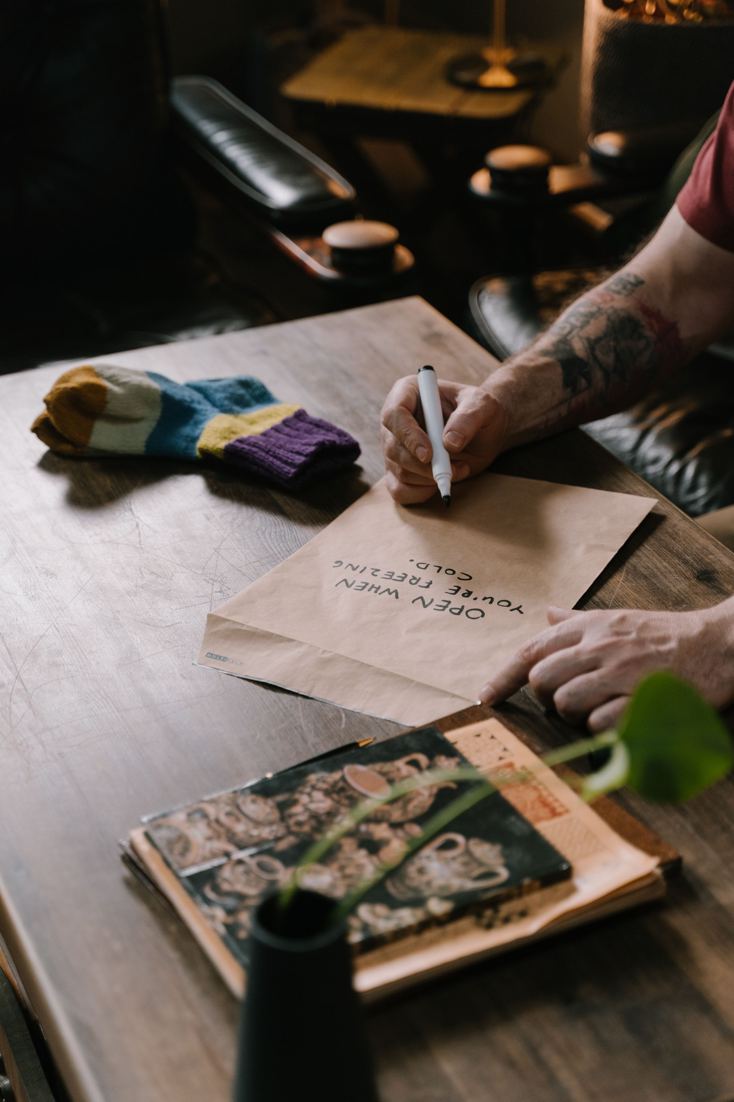 Person Writing On Brown Paper · Free Stock Photo