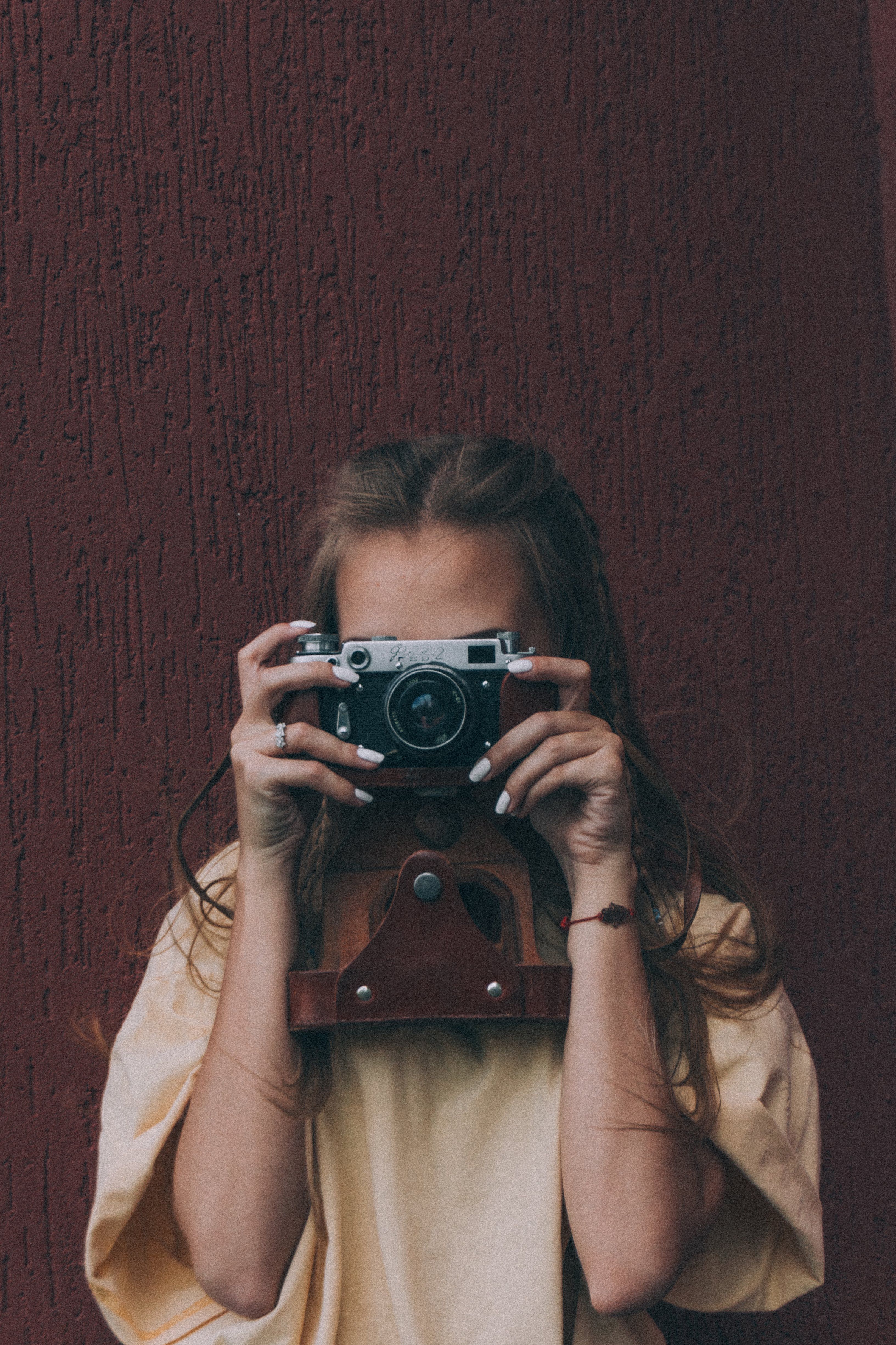 Anonymous woman photographing with retro camera in studio · Free Stock ...