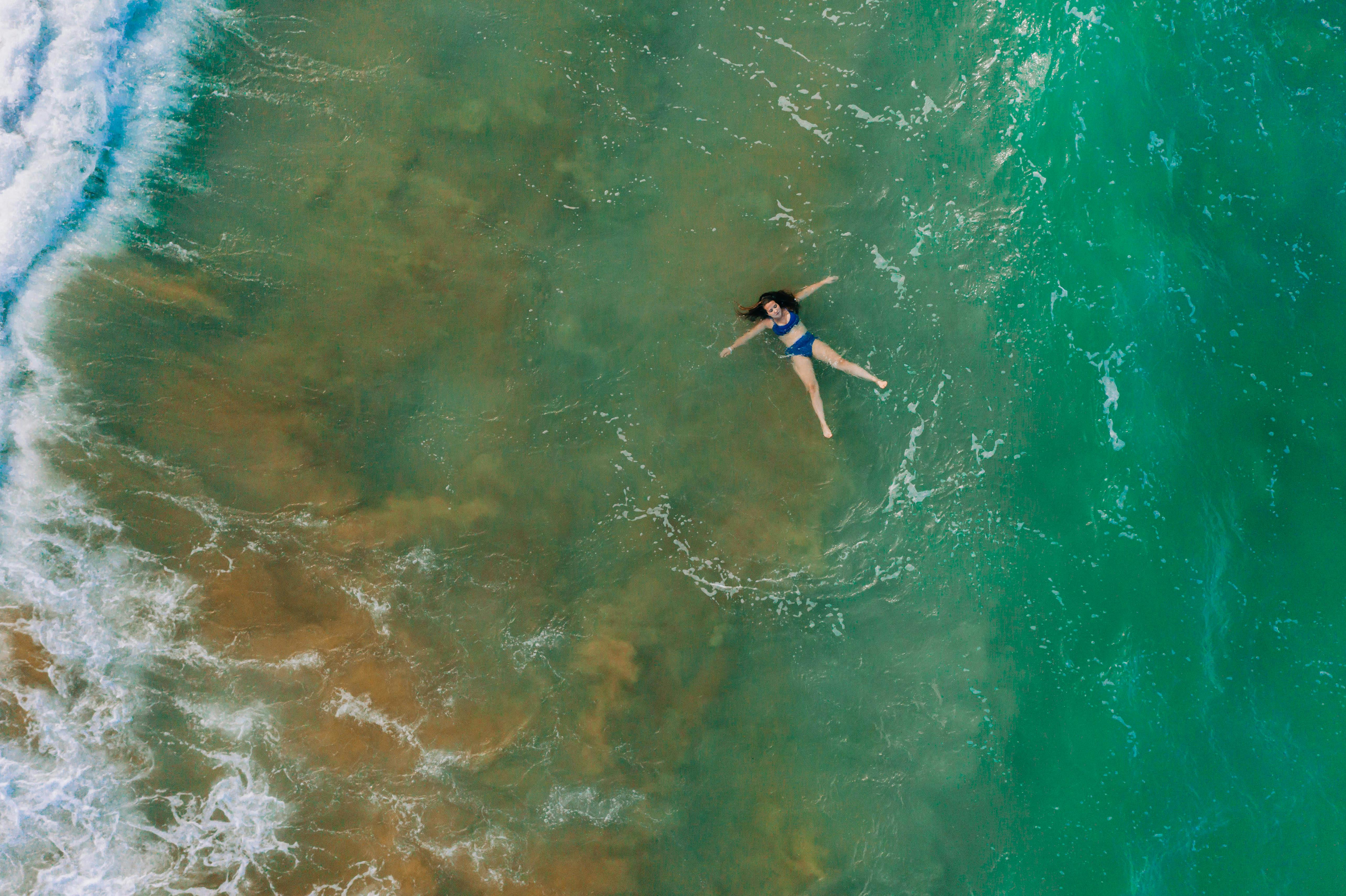 Woman in Blue Bikini Floating on the Sea · Free Stock Photo