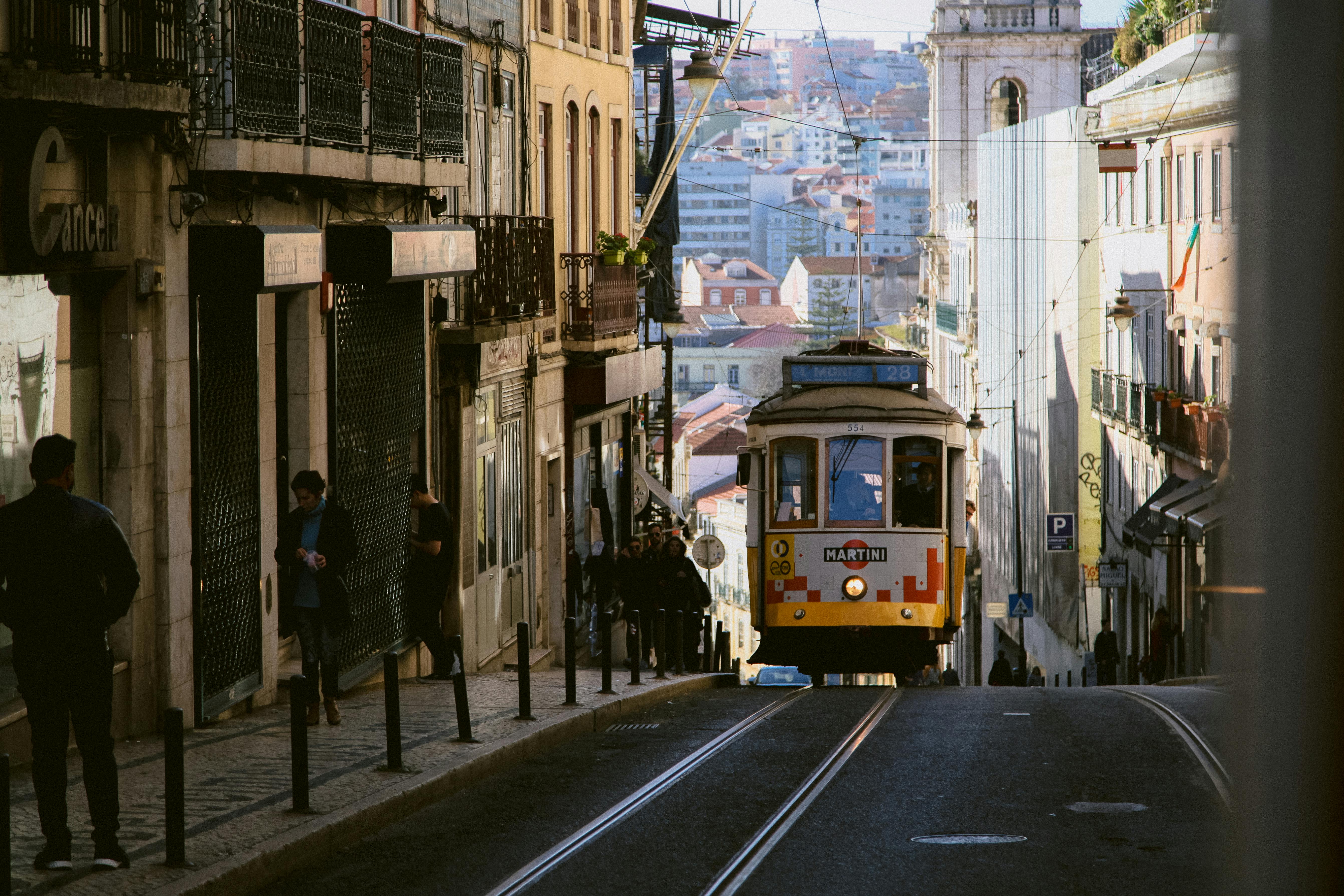 Moving Tramway Near Busy People Walking on the Side of the Street ...