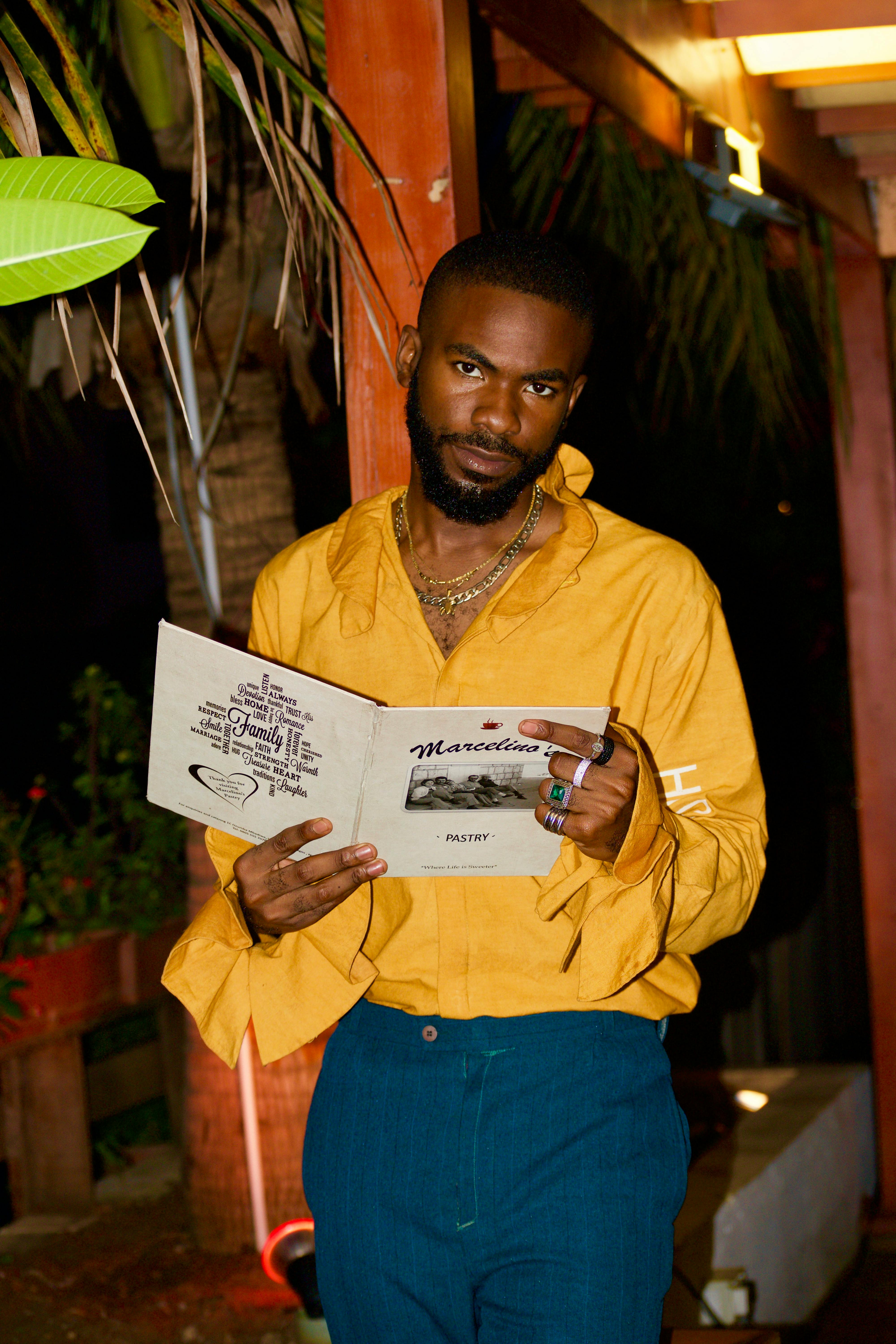 Man in Yellow Long Sleeves Holding a Book · Free Stock Photo