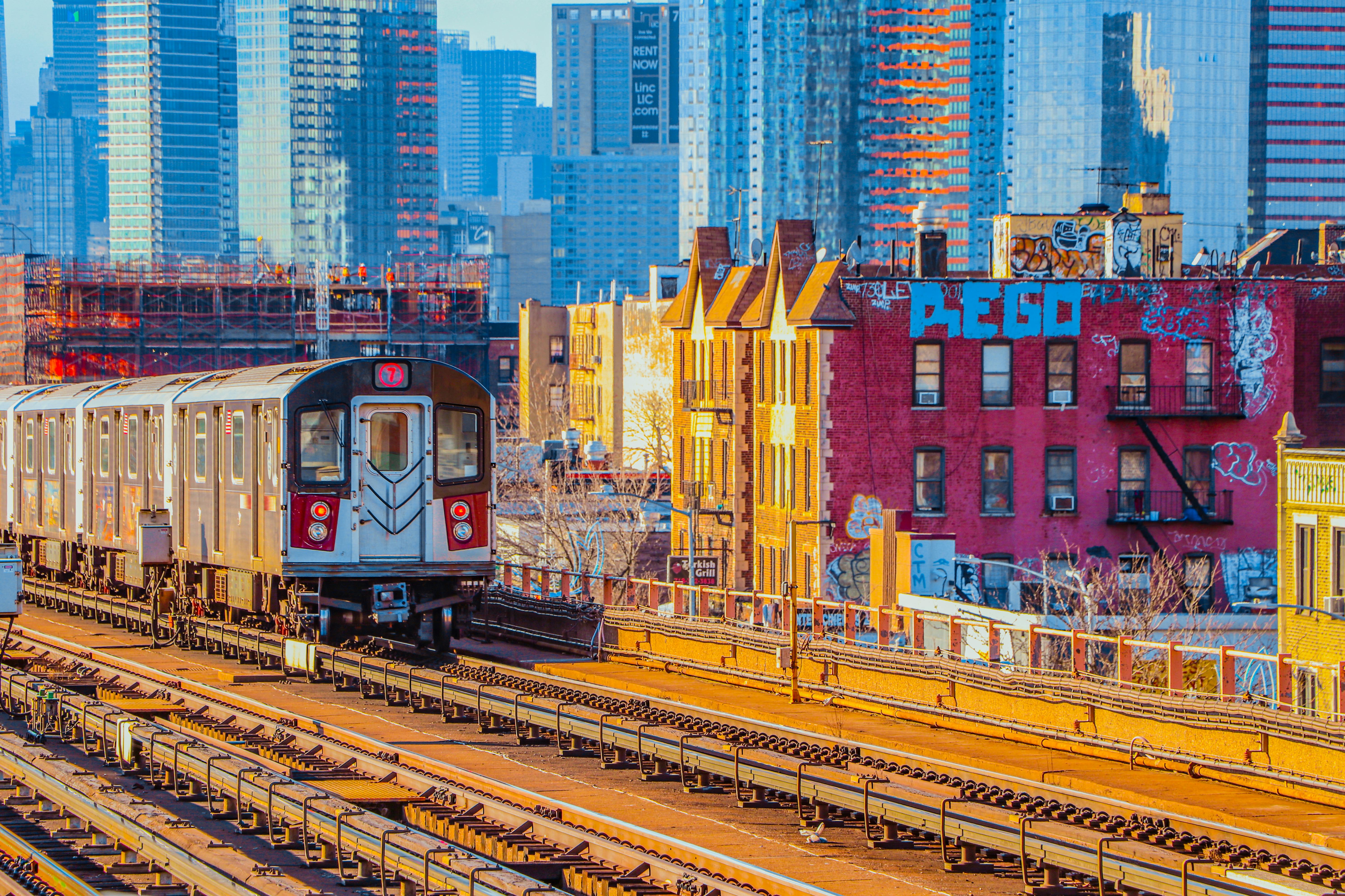 Train near Buildings during Dusk · Free Stock Photo