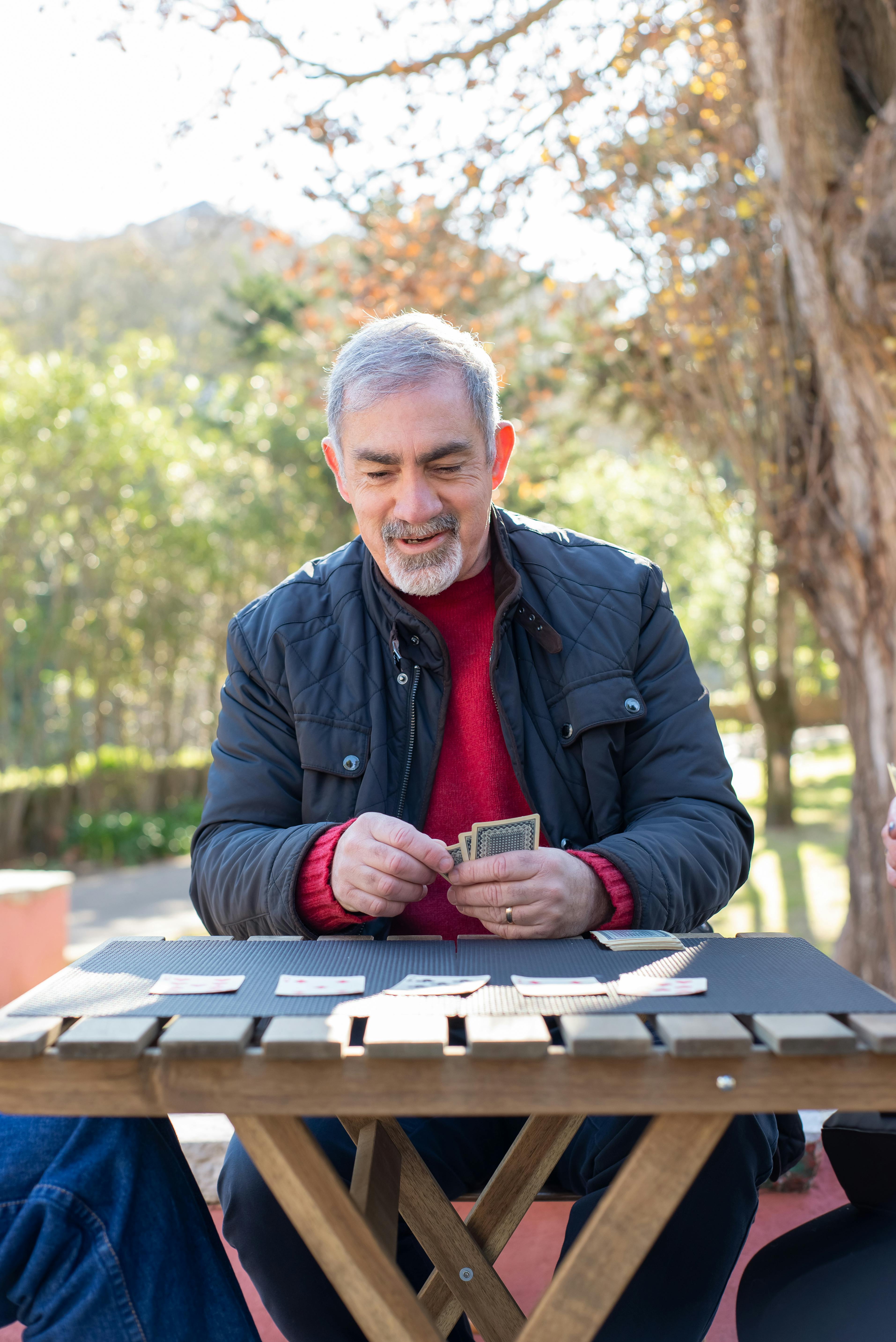 A Elderly Man Playing Solitaire in the Park · Free Stock Photo