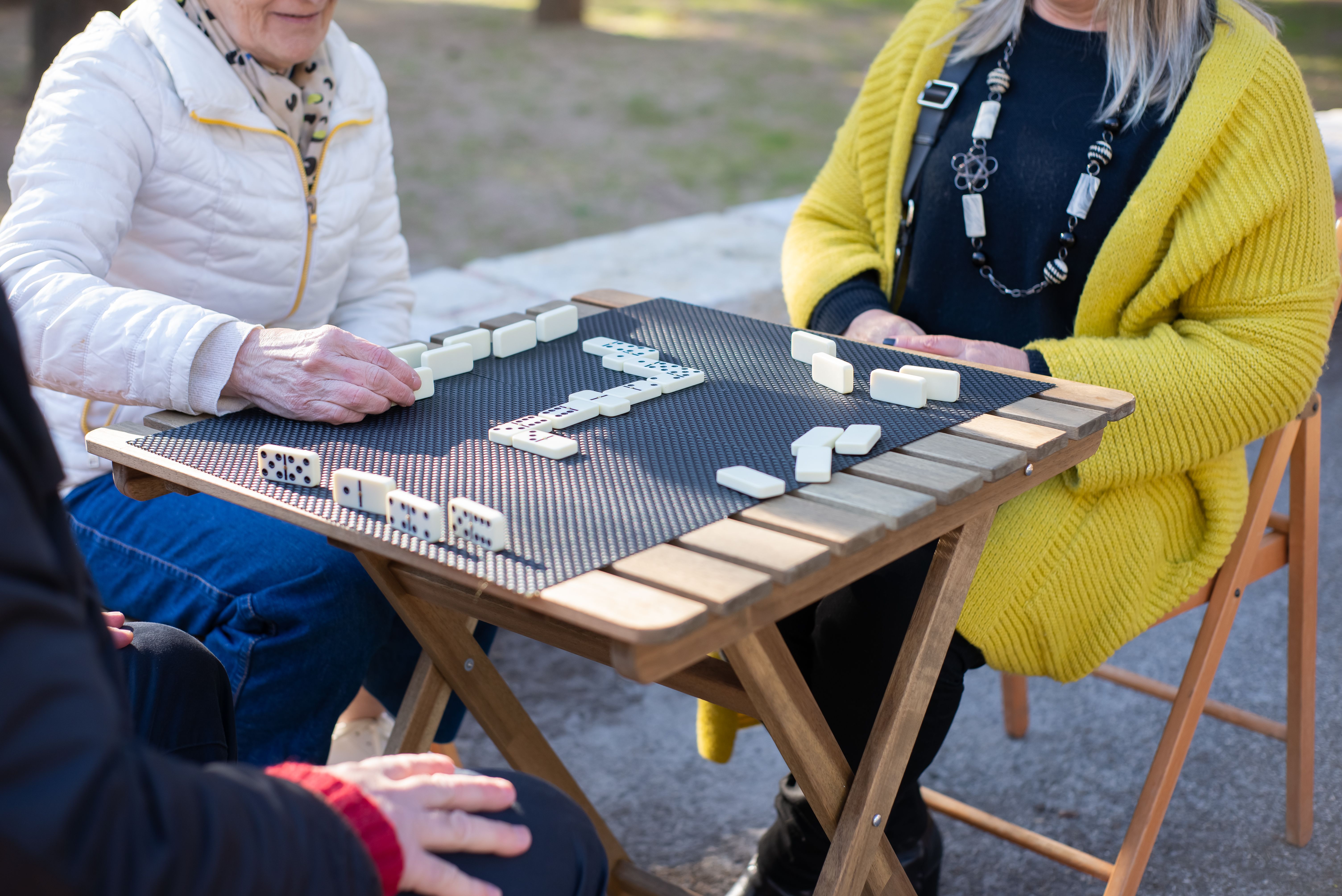 Four People Playing Dominoes · Free Stock Photo