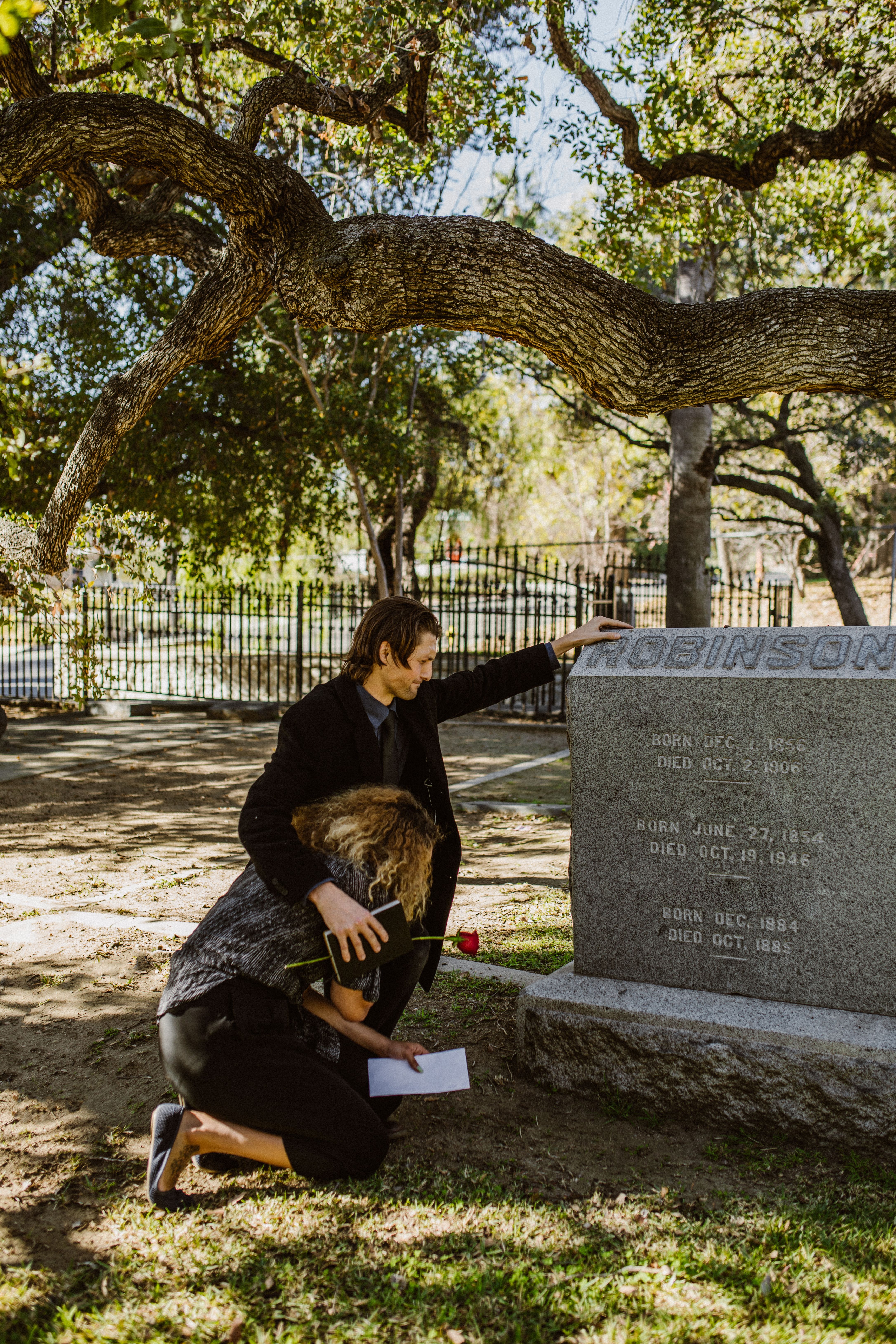 Grieving Couple Beside a Tombstone · Free Stock Photo