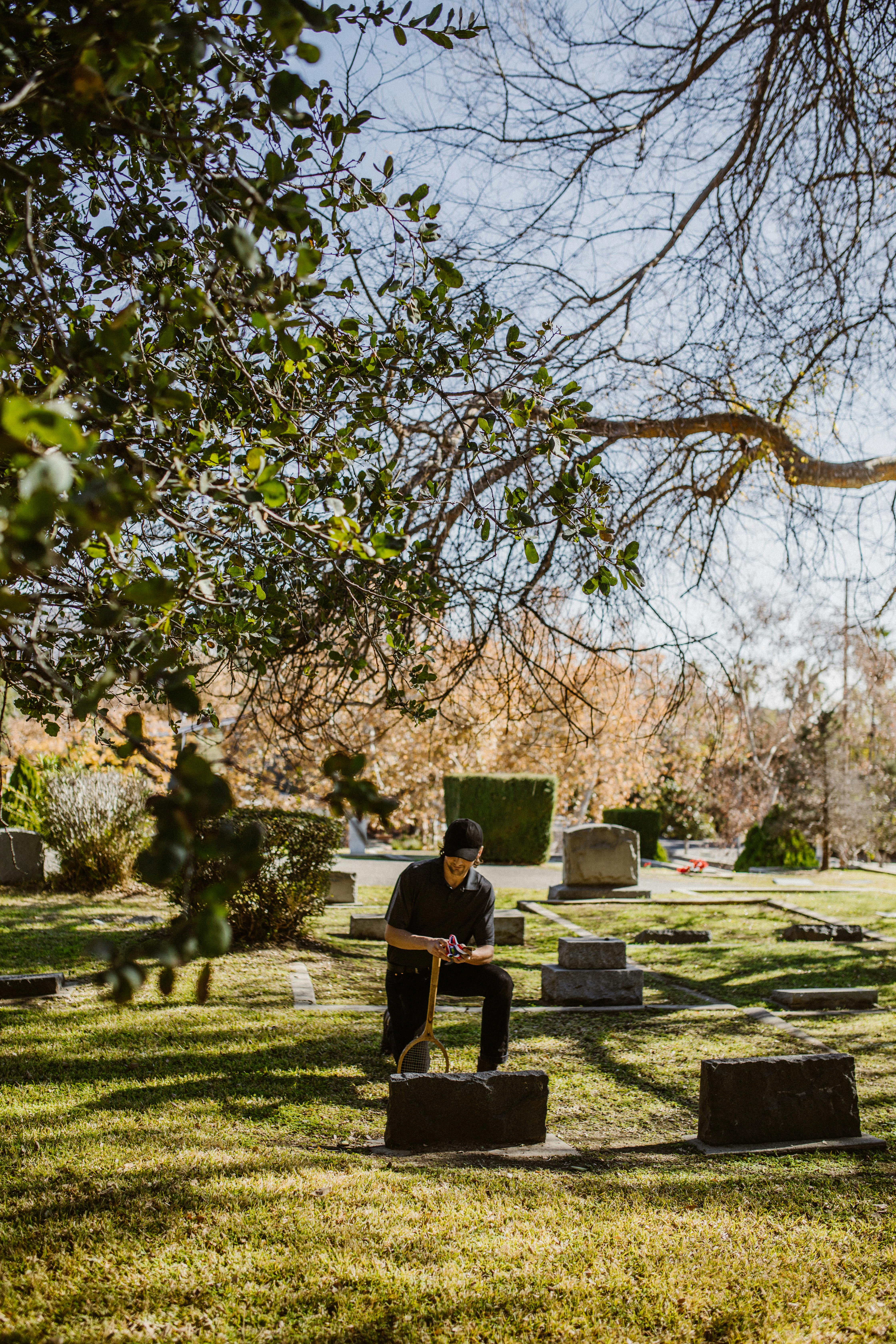 Man grieving on a Cemetary · Free Stock Photo