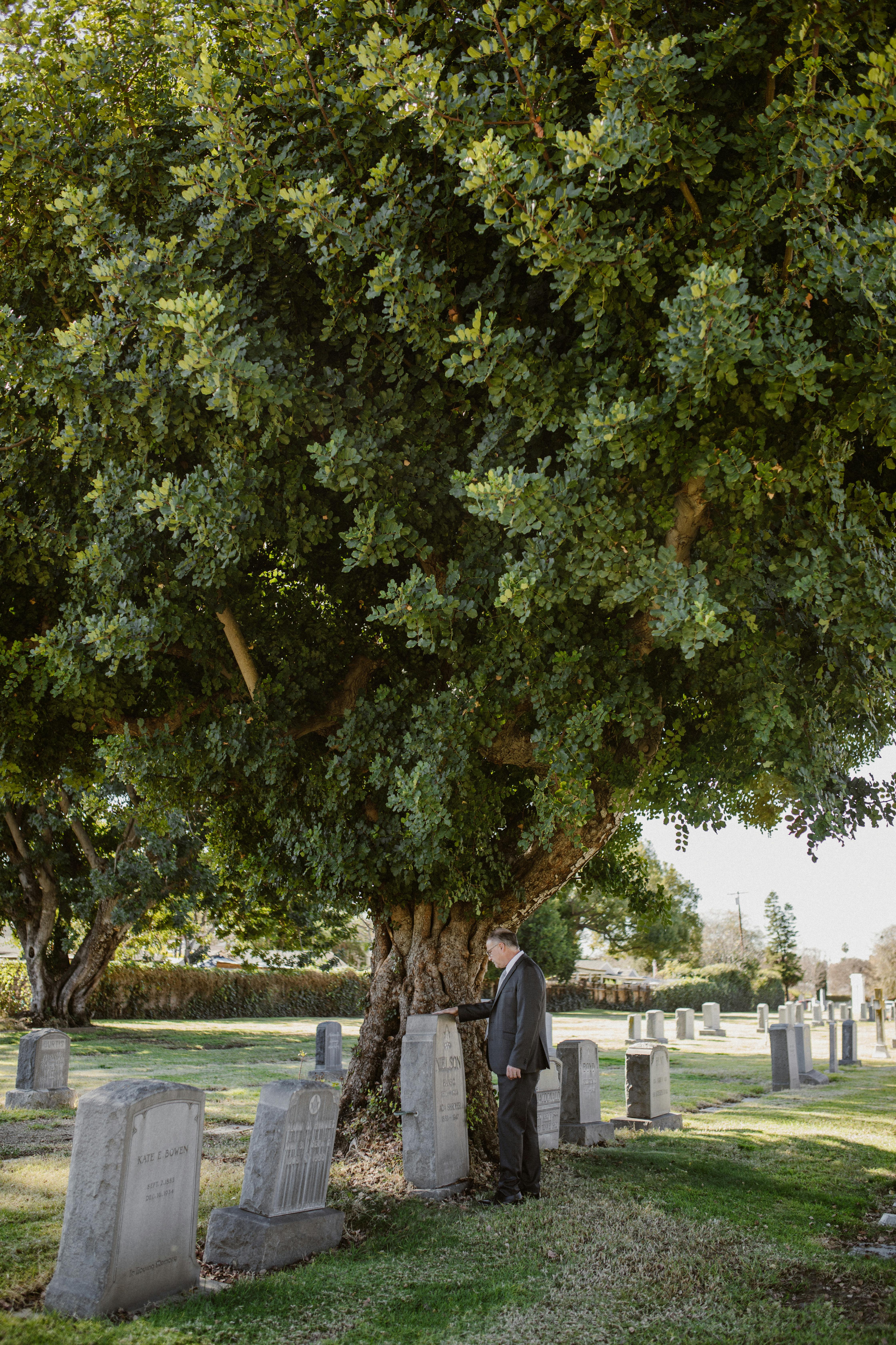 Photo of Man standing in front of Gravestone · Free Stock Photo