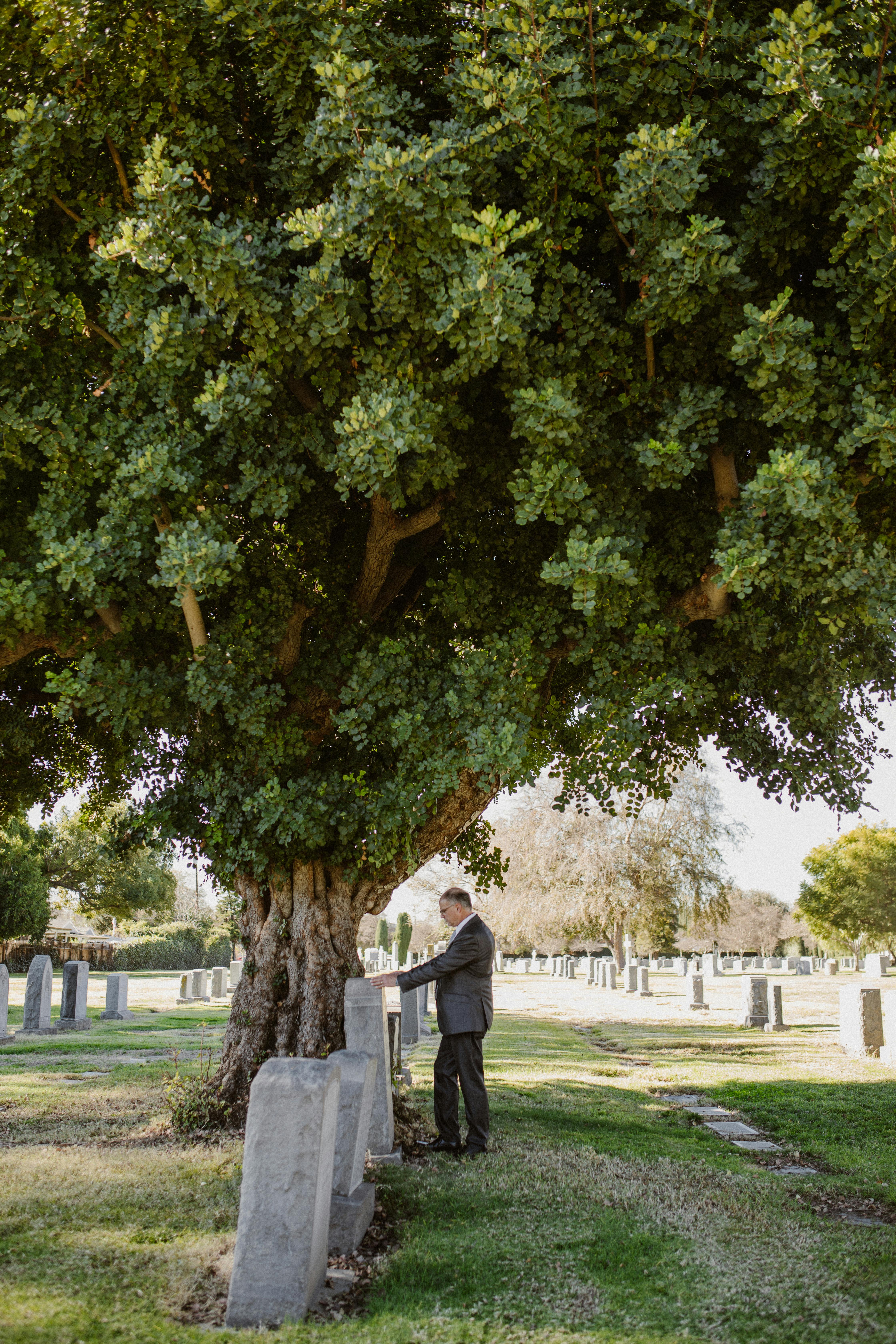 Lonely Man Standing on a Grave · Free Stock Photo