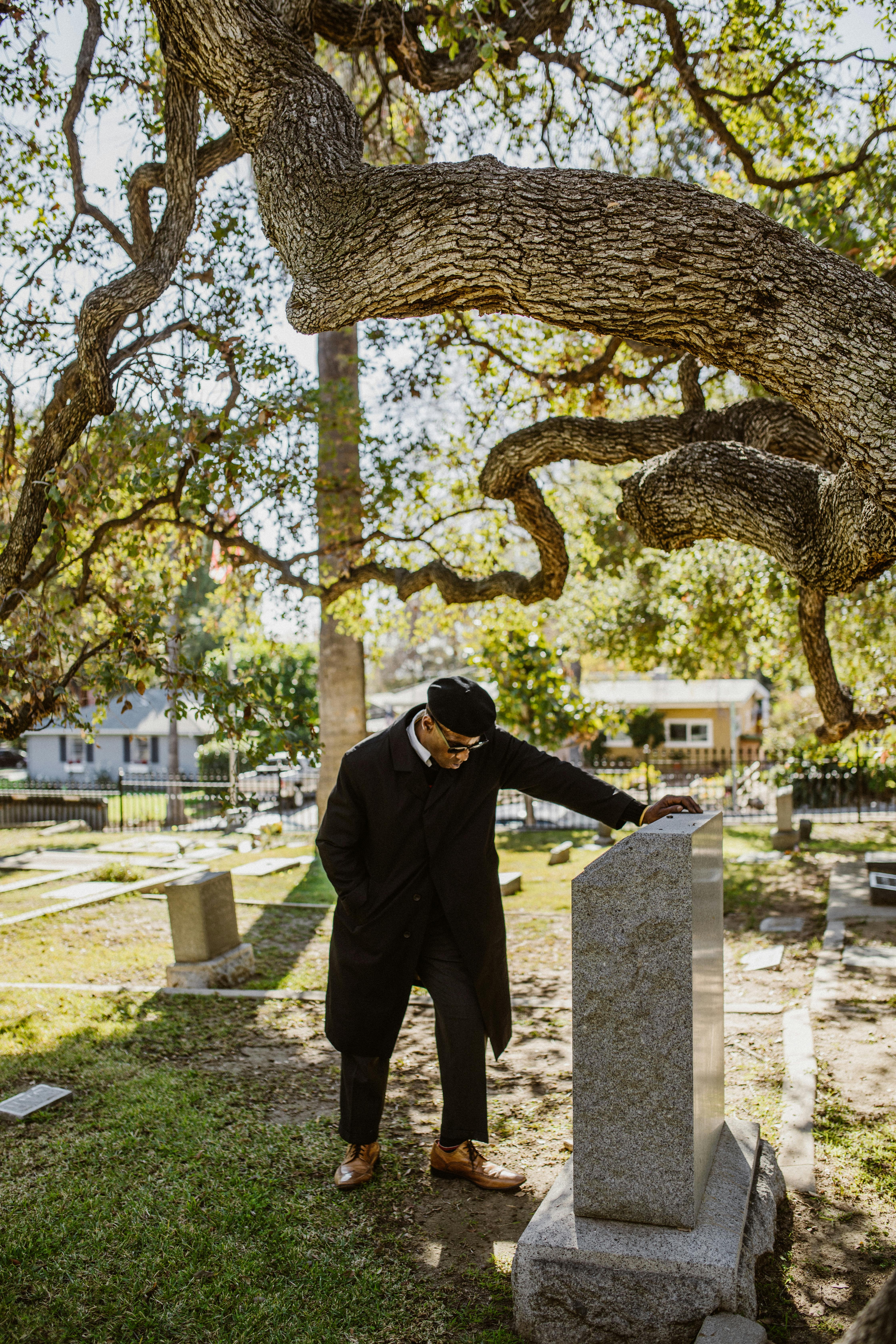 A Man Touching a Tombstone · Free Stock Photo
