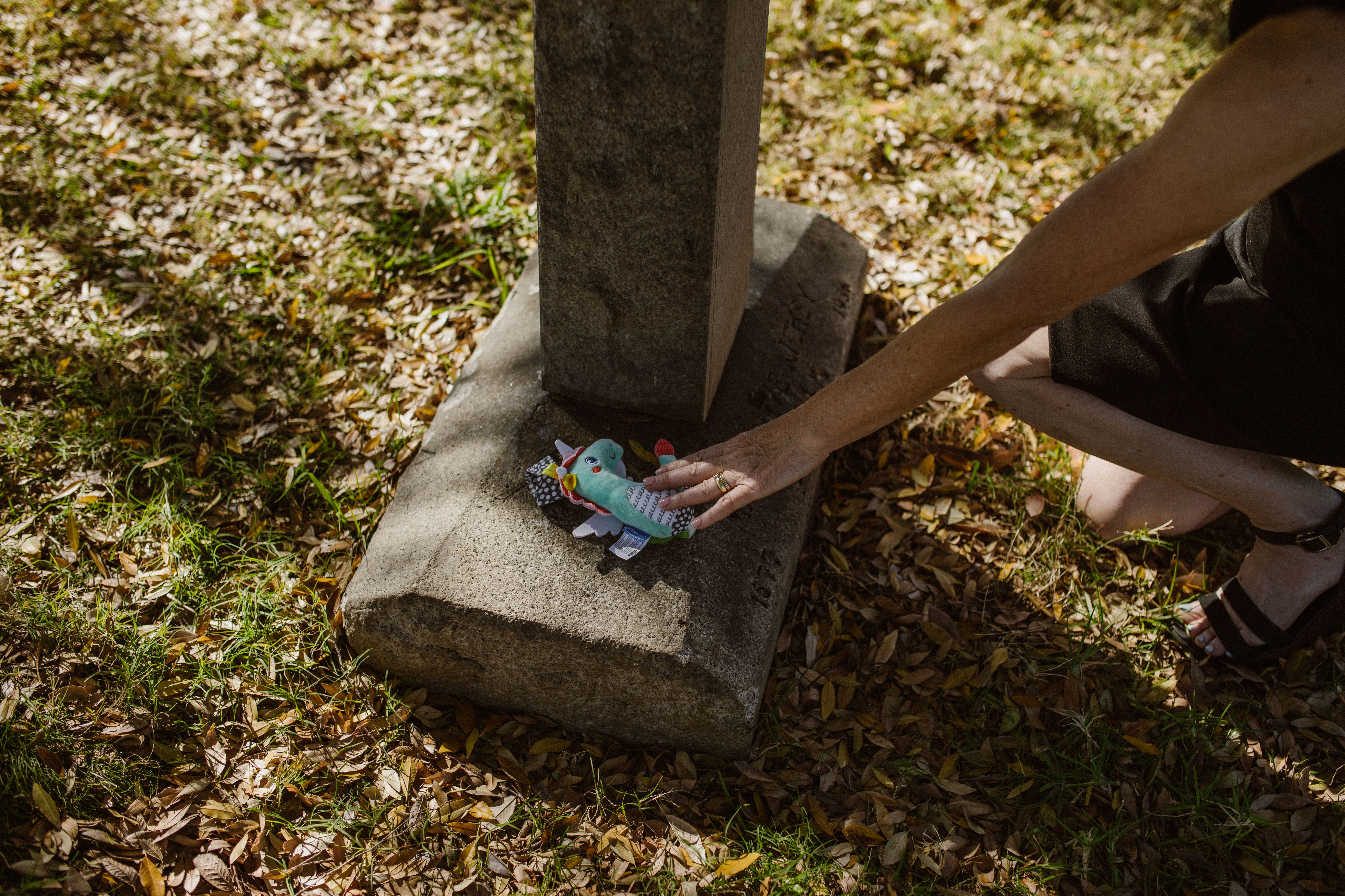 Woman putting Stuffed Toy on Gravestone · Free Stock Photo