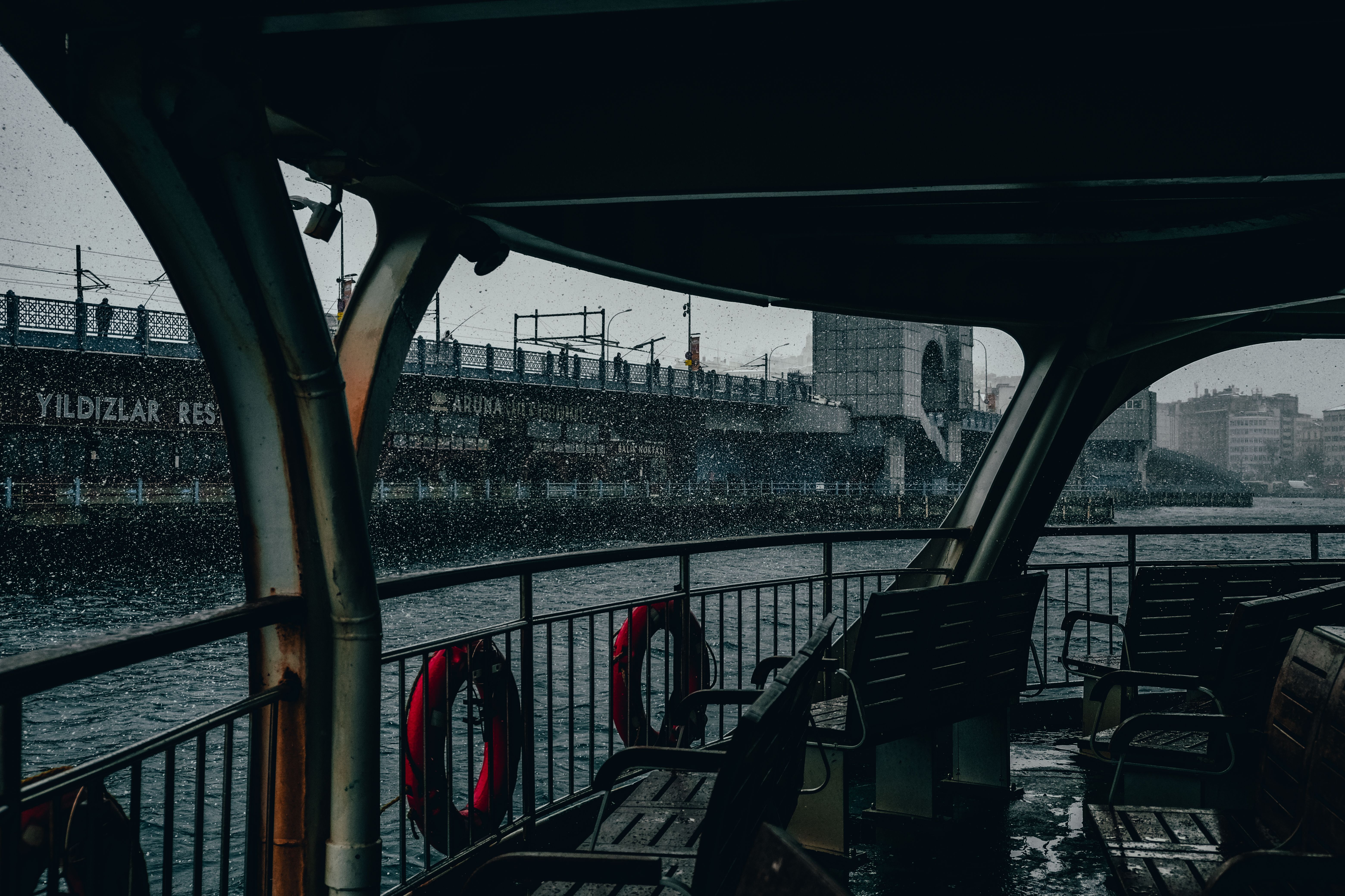 Empty ferry with benches on river near embankment in winter · Free ...