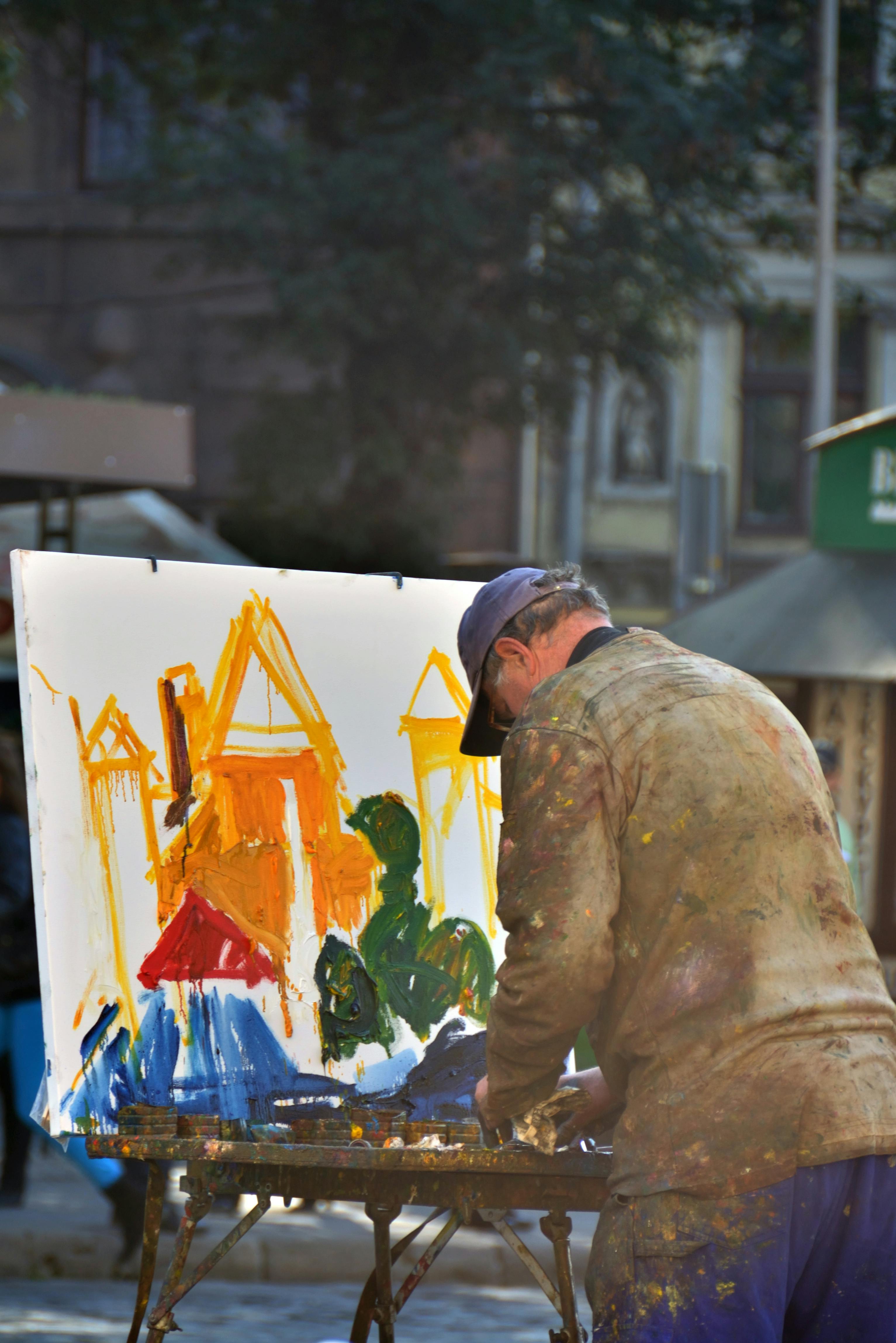 Man Painting on Canvas · Free Stock Photo