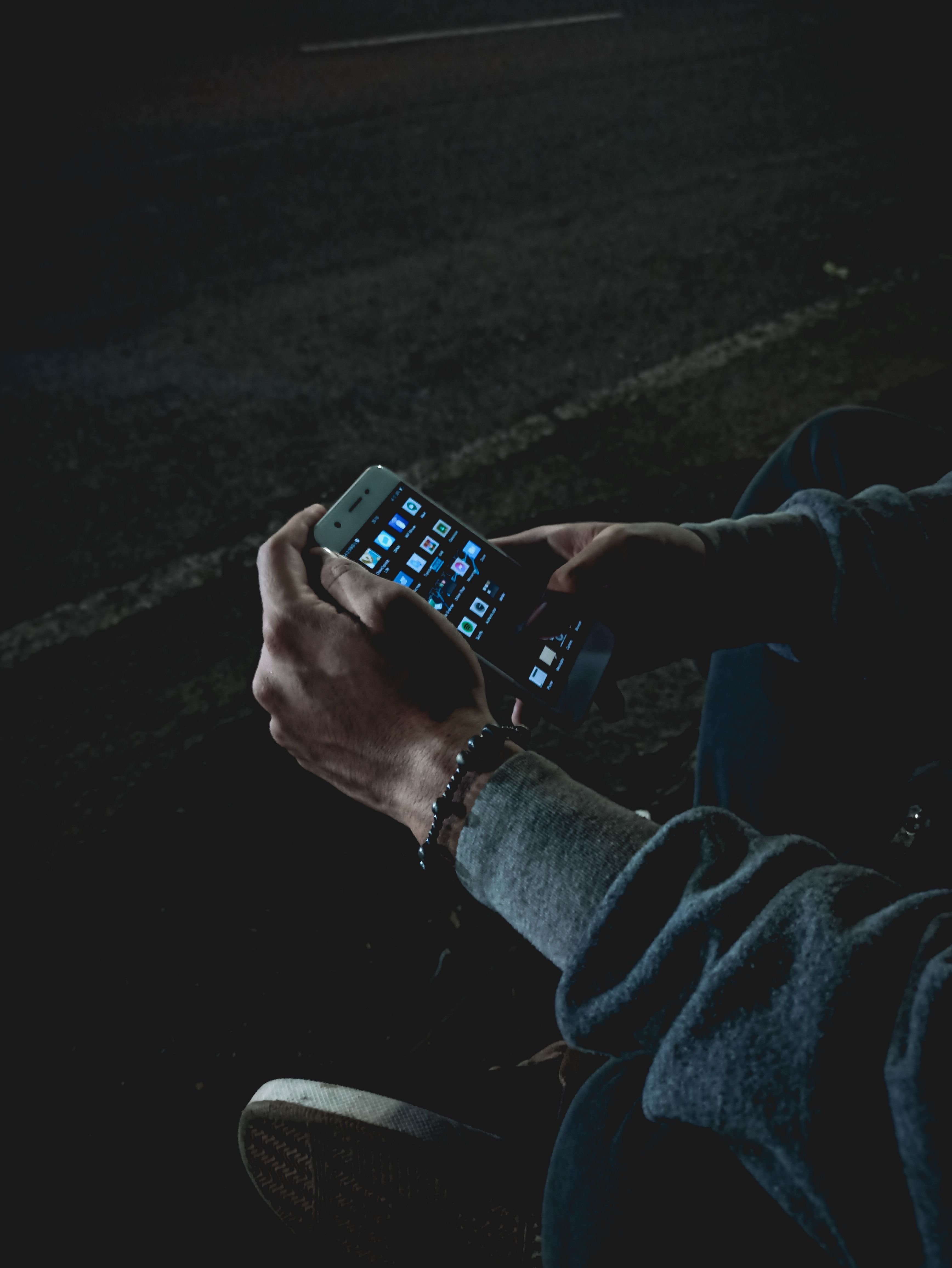 Person Holding Black Phone with Red String · Free Stock Photo