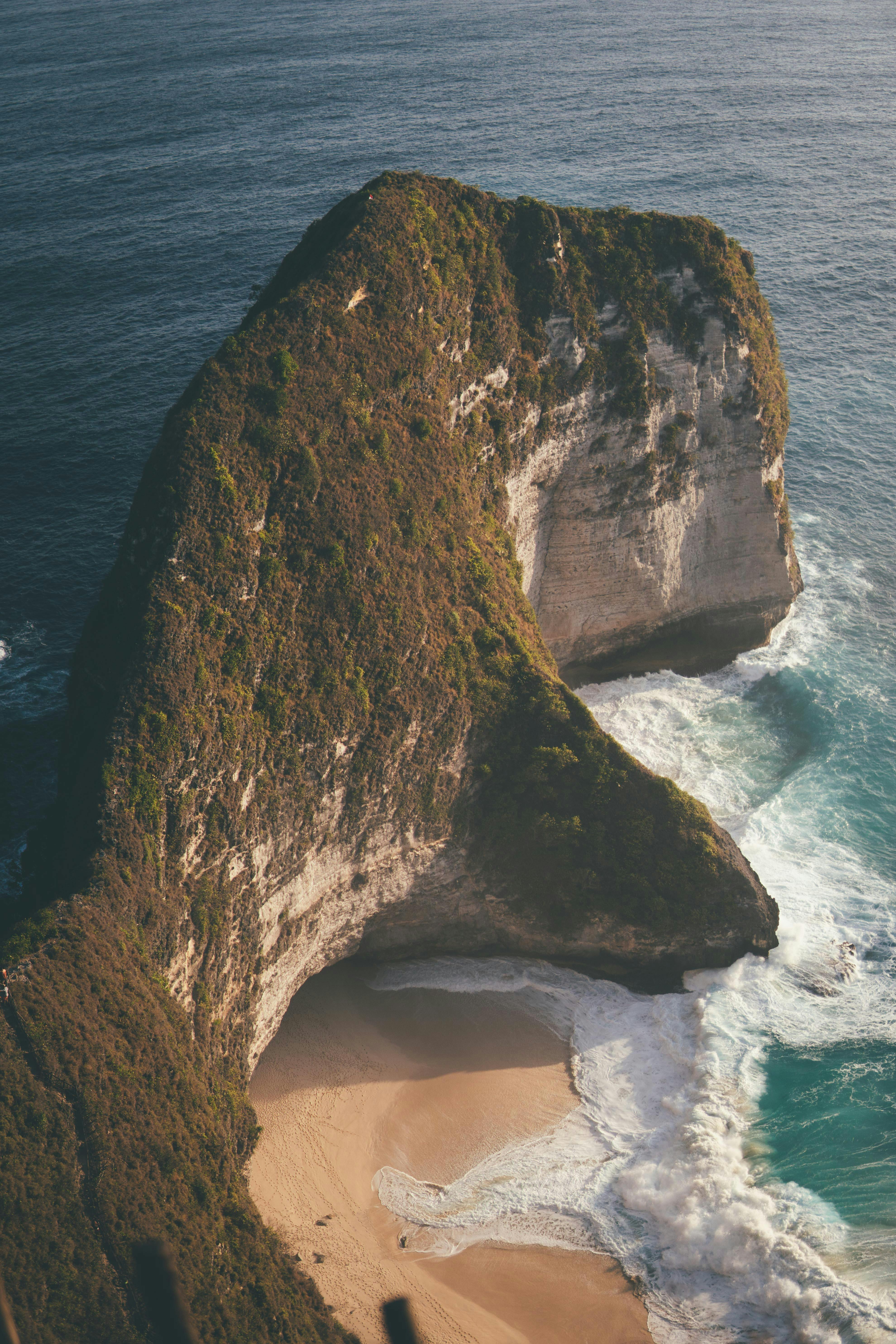 Aerial View of a Cliff and Sandy Beach by a Sea · Free Stock Photo