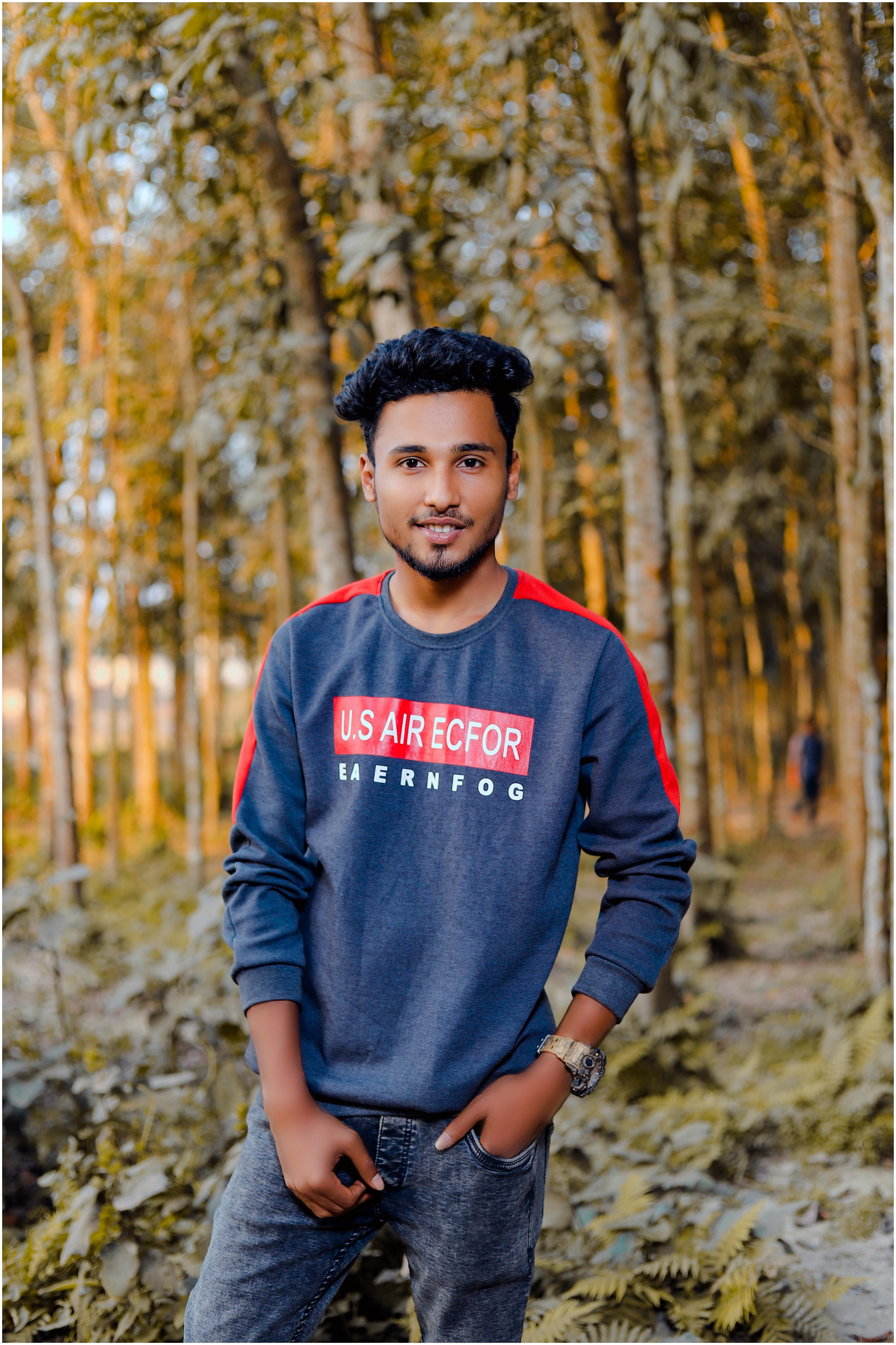 Portrait of a Young Brunette Man in a Forest · Free Stock Photo