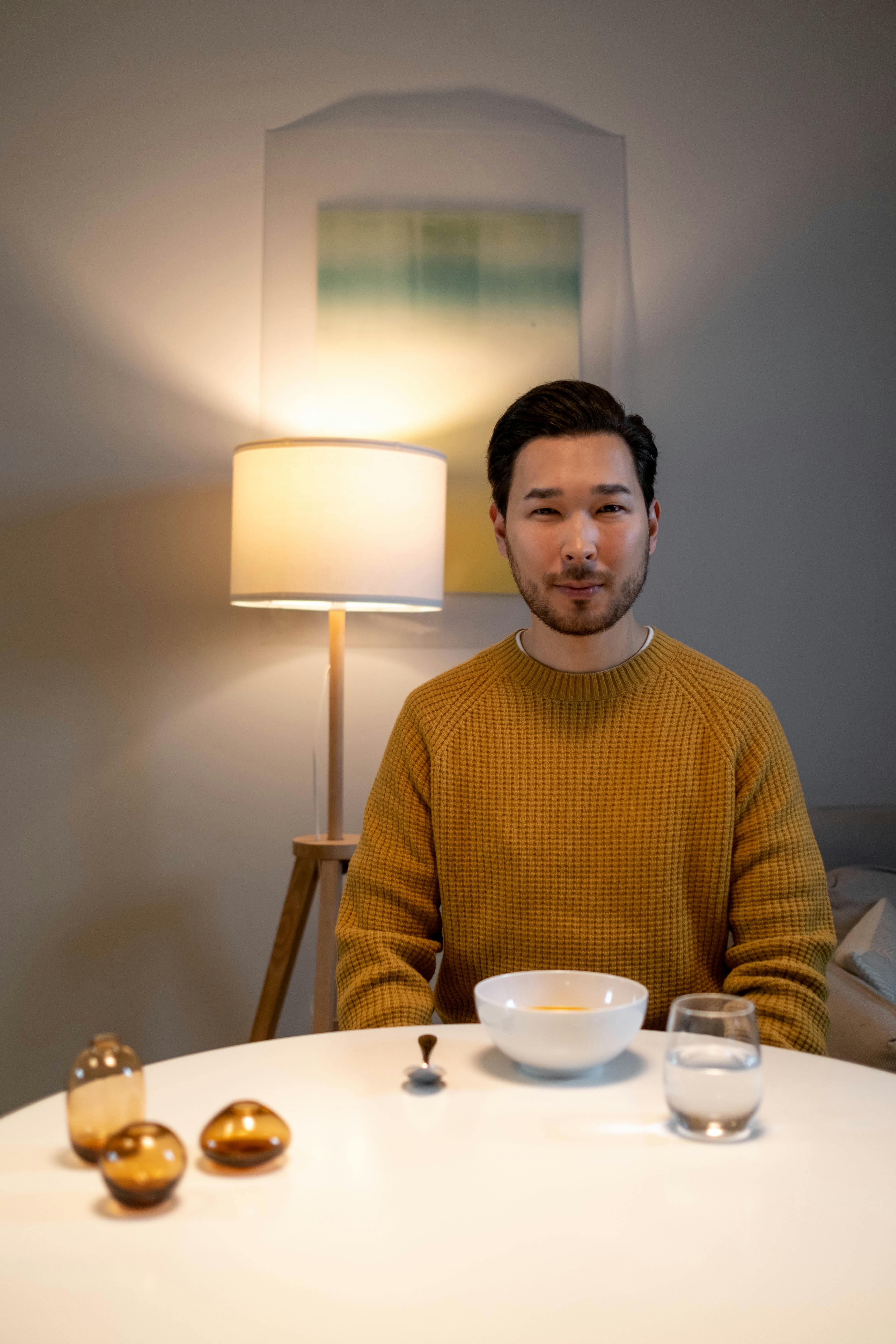 Man Eating From a Bowl with Glass of Water · Free Stock Photo