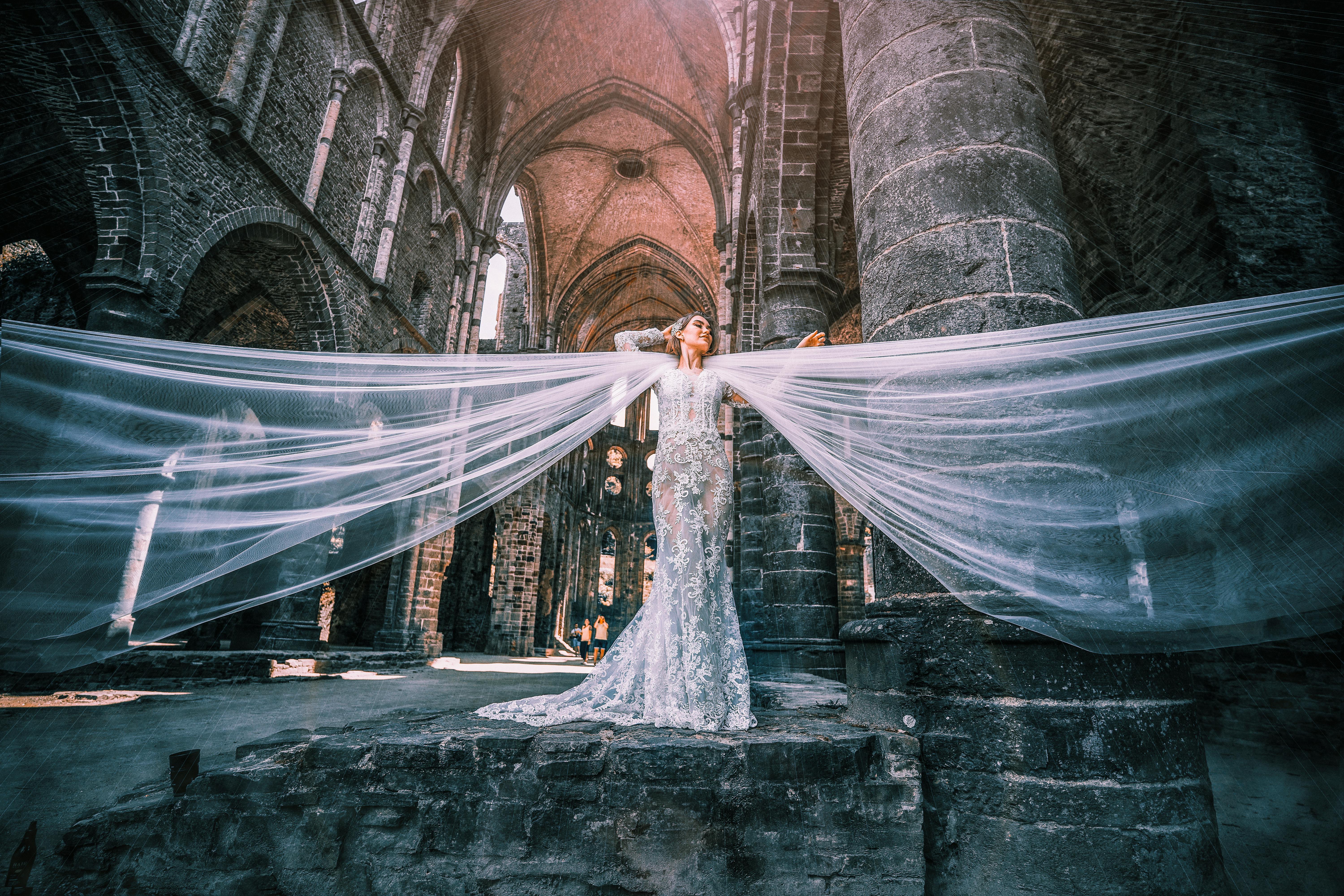Woman in a Lace Wedding Dress Posing in a Castle · Free Stock Photo