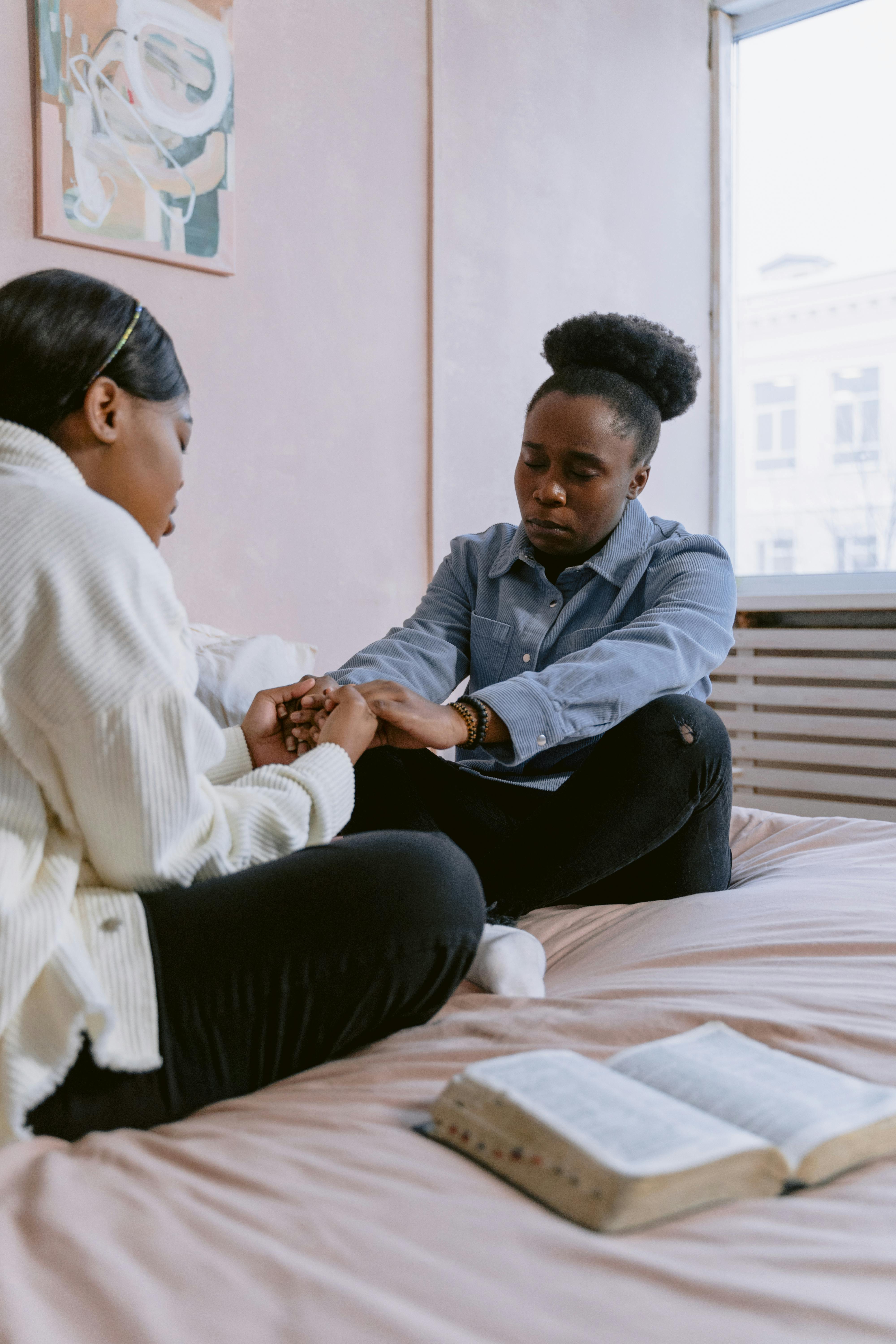 Women Sitting on Bed Praying · Free Stock Photo