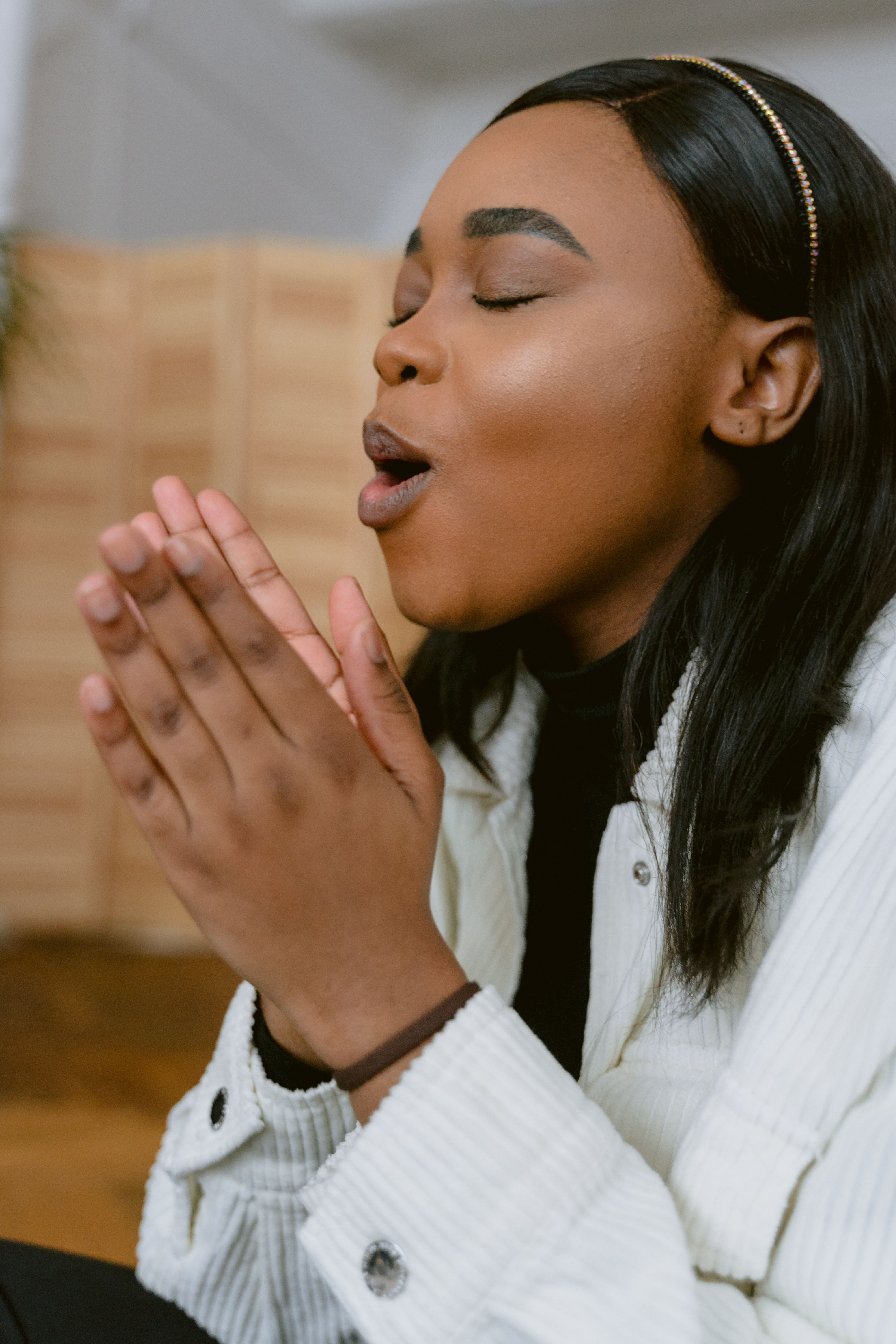 Woman in White Jacket Praying · Free Stock Photo
