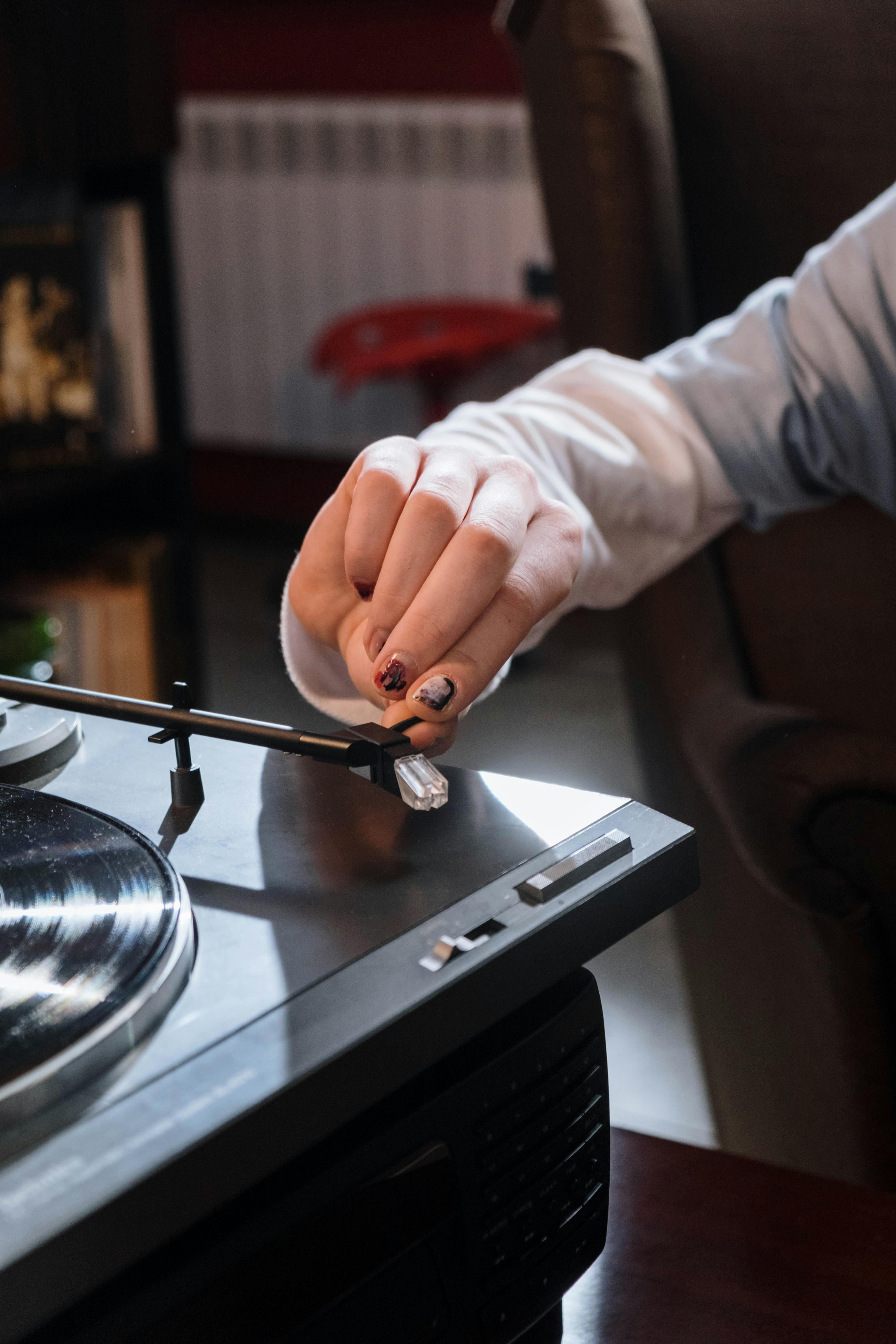 A Person Holding a Turntable's Headshell · Free Stock Photo
