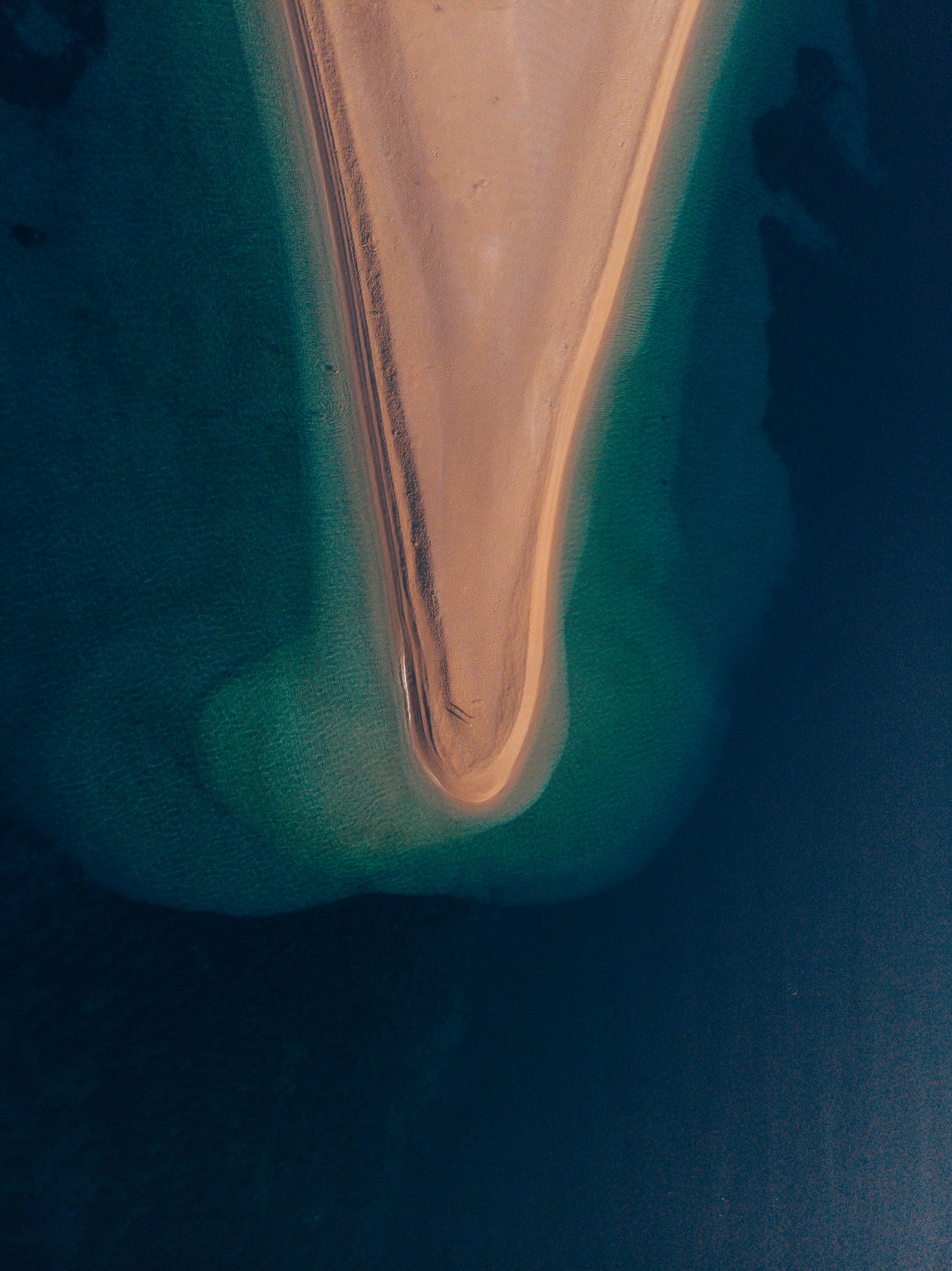 Aerial Photography of Rocks Beside Body of Water · Free Stock Photo