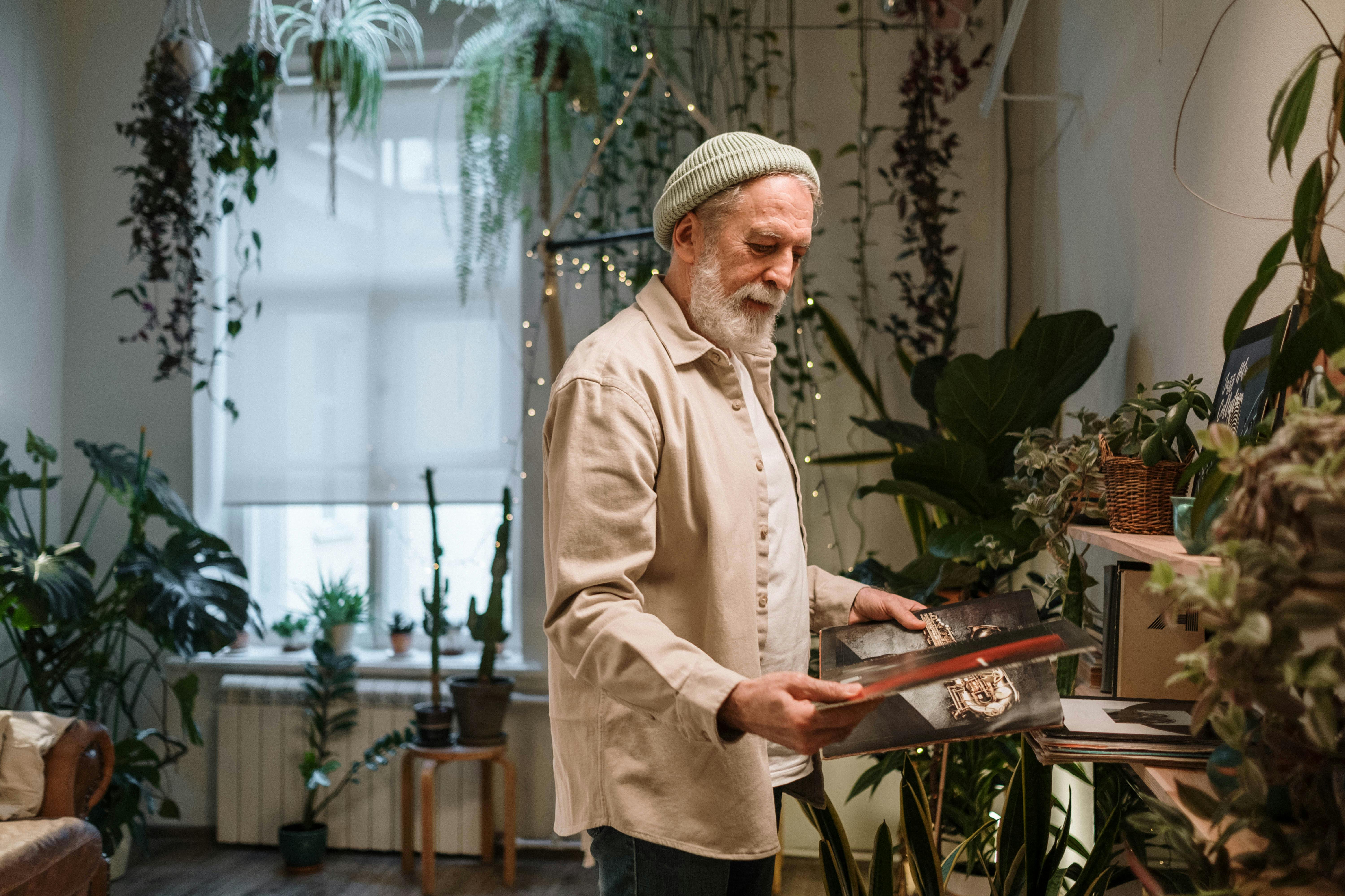 A Man Standing Near the Green Plants · Free Stock Photo