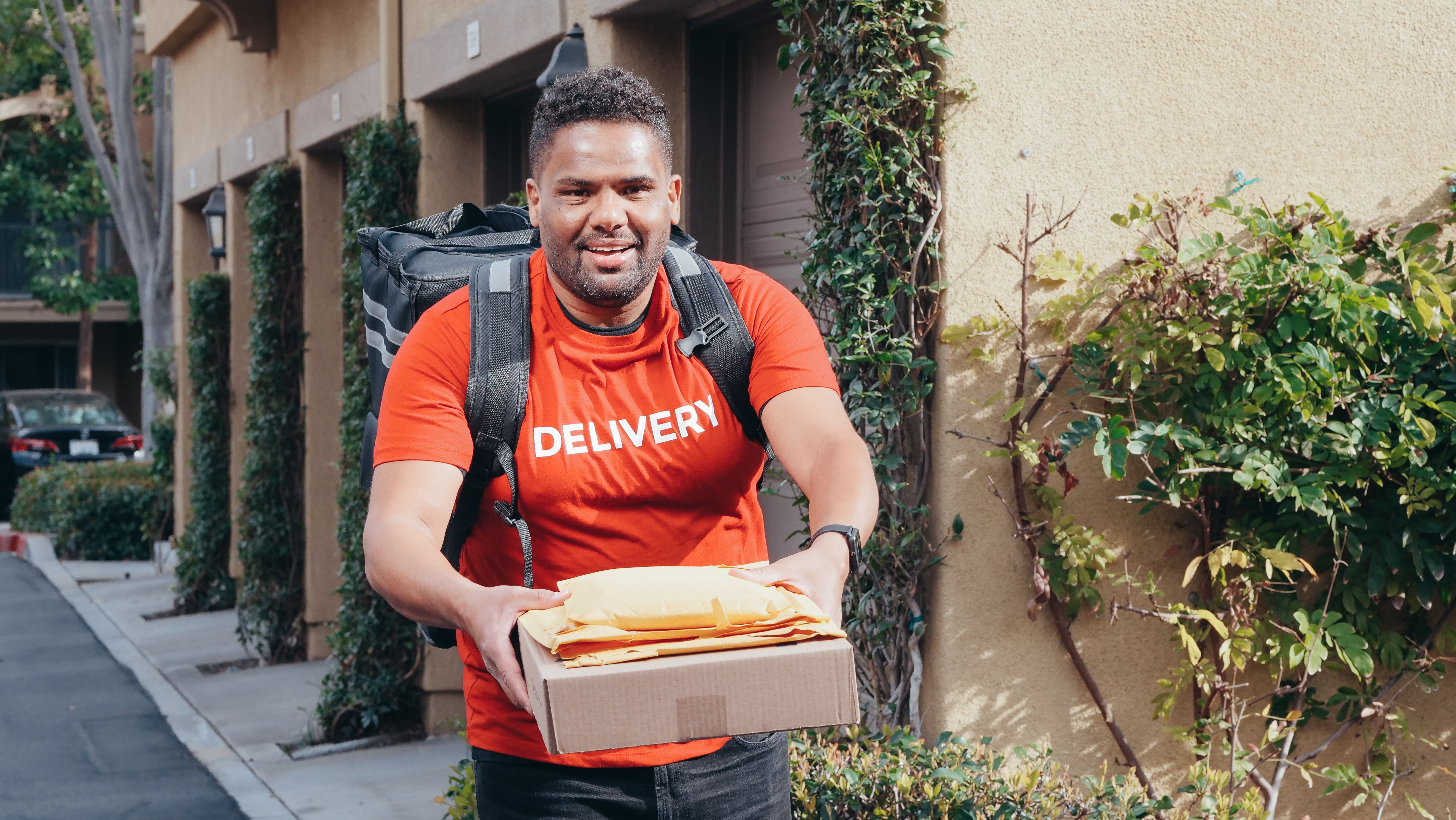 A Delivery Man Handing Packages · Free Stock Photo