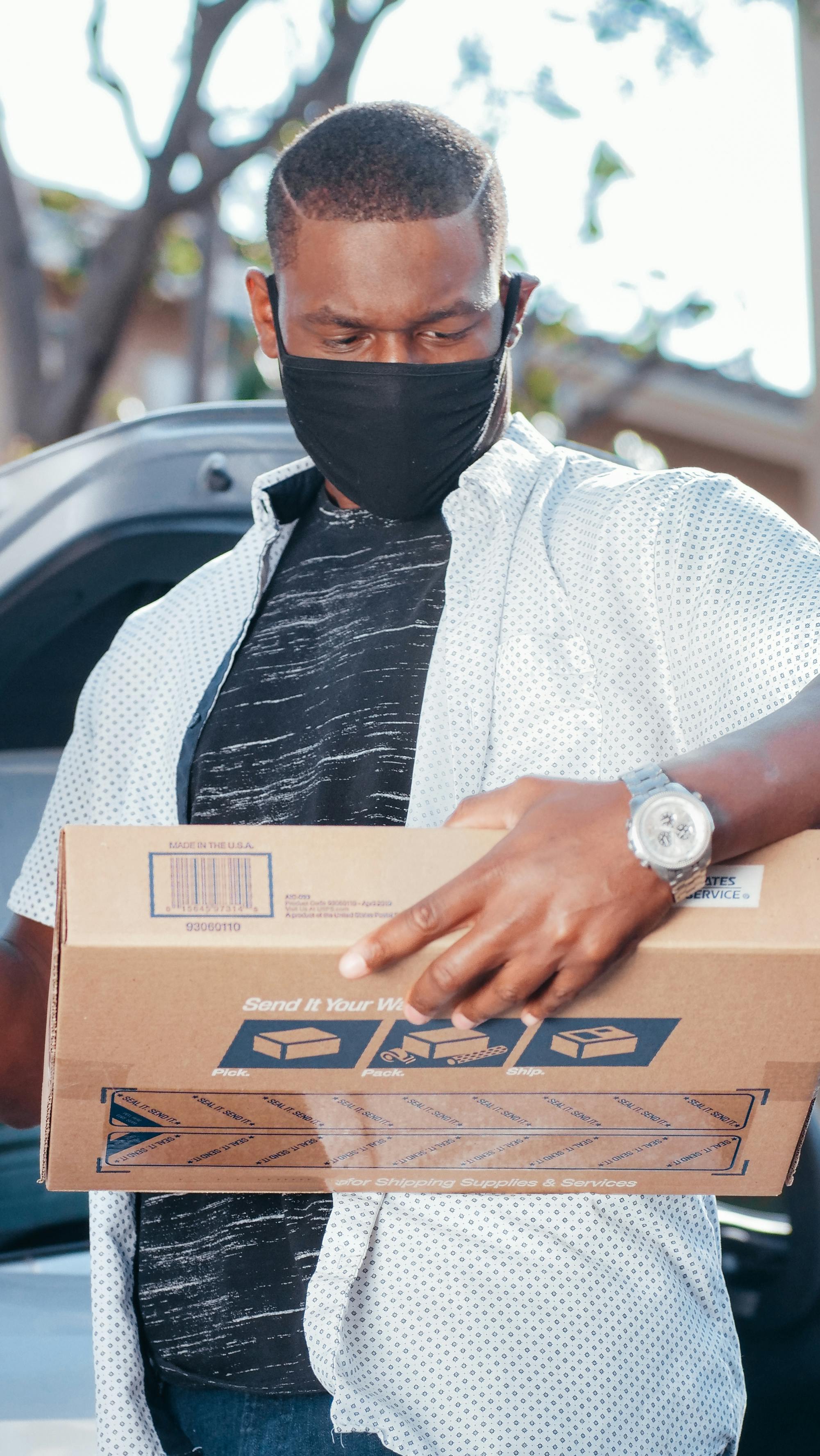 Man Holding a Box · Free Stock Photo