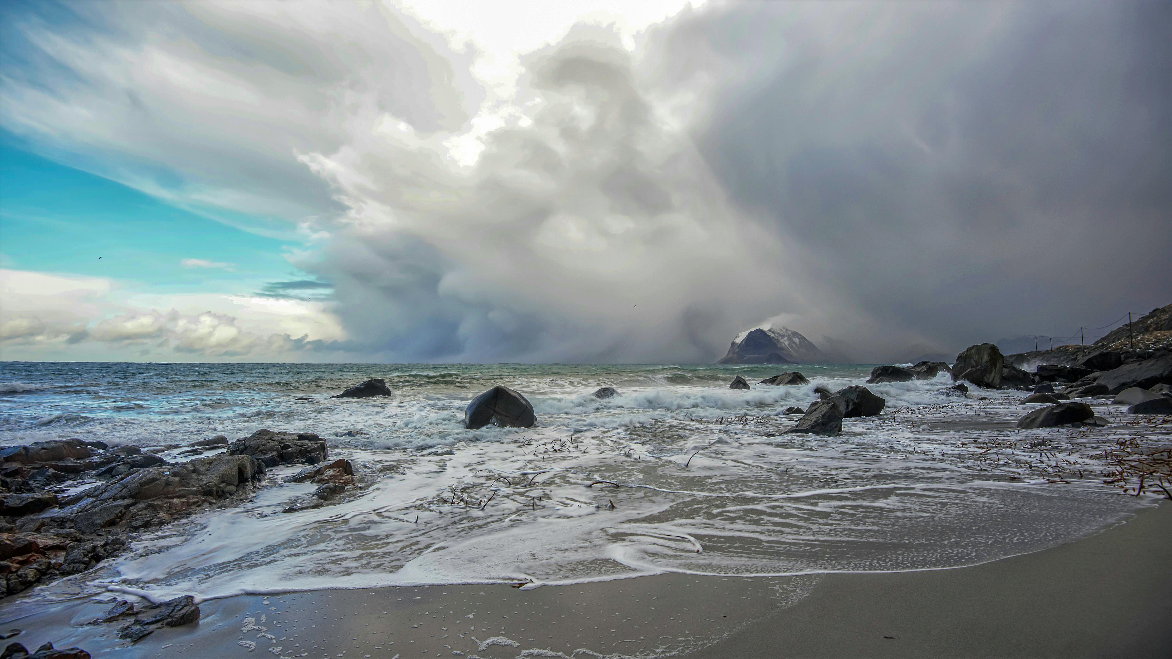 Brown Rock Formation on Sea Shore Under White Clouds · Free Stock Photo