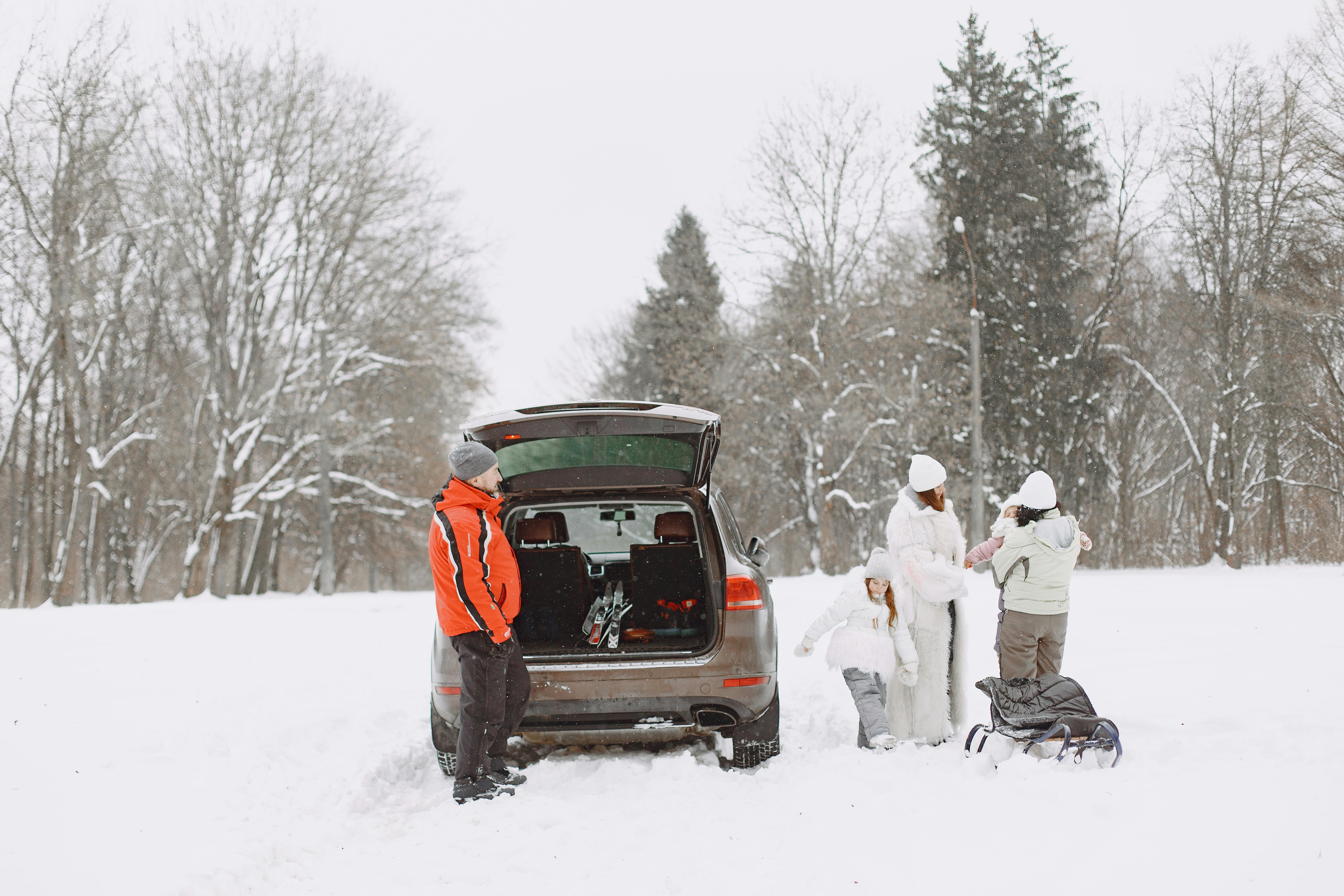 People Standing on Snow Covered Ground Beside a Vehicle · Free Stock Photo