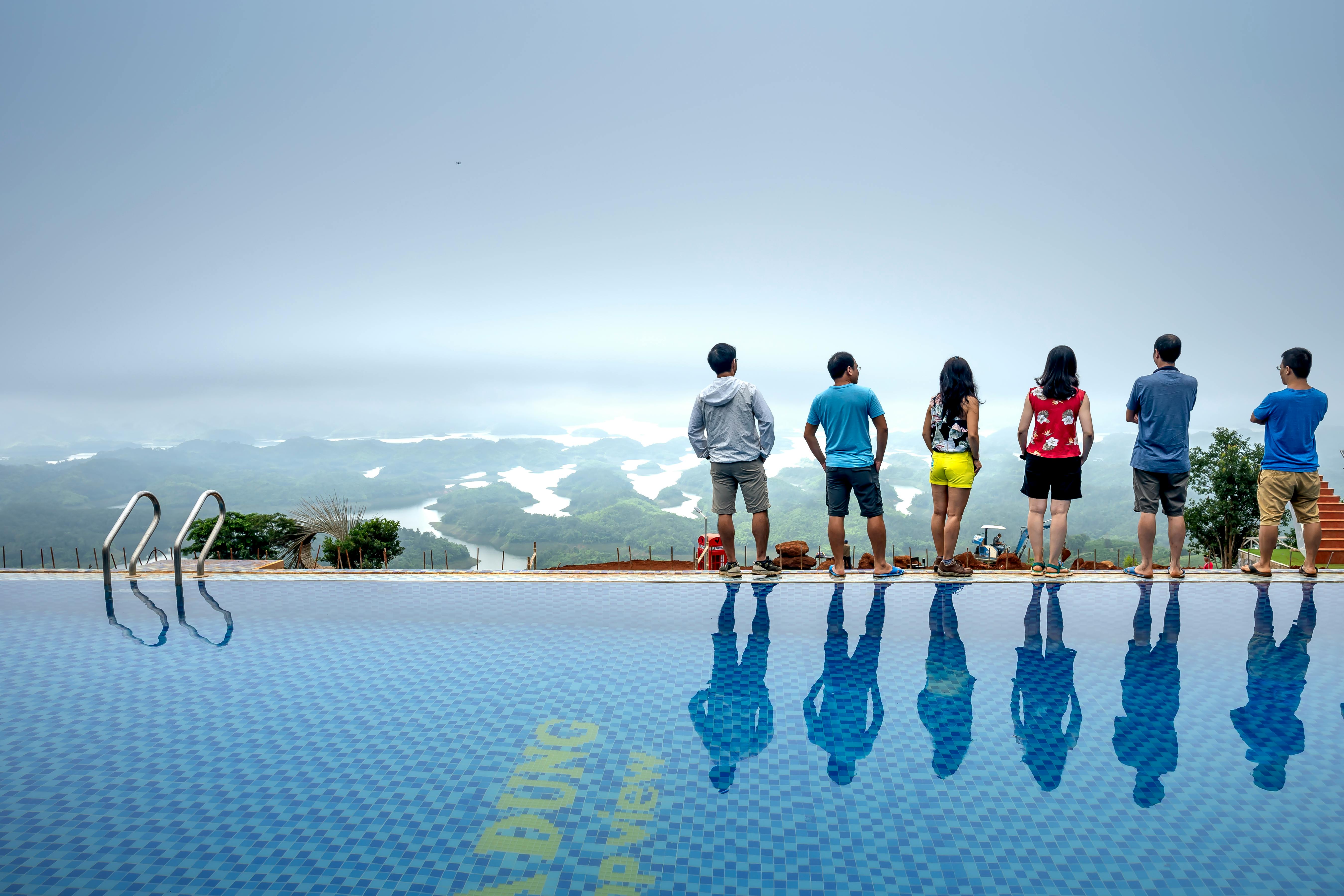Group of People Standing by the Swimming Pool and Looking at the ...