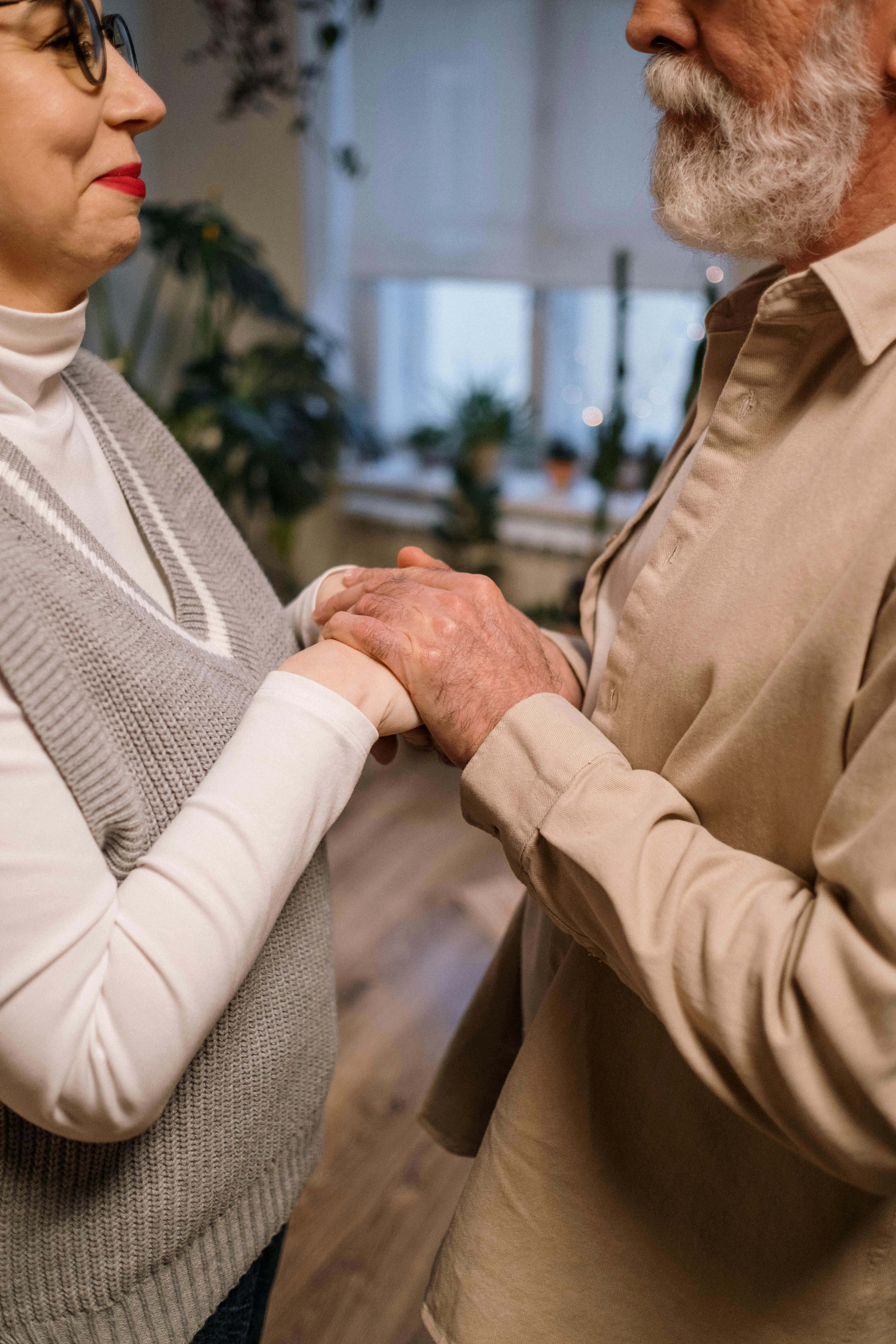 Photo of an Elderly Couple Holding Hands · Free Stock Photo