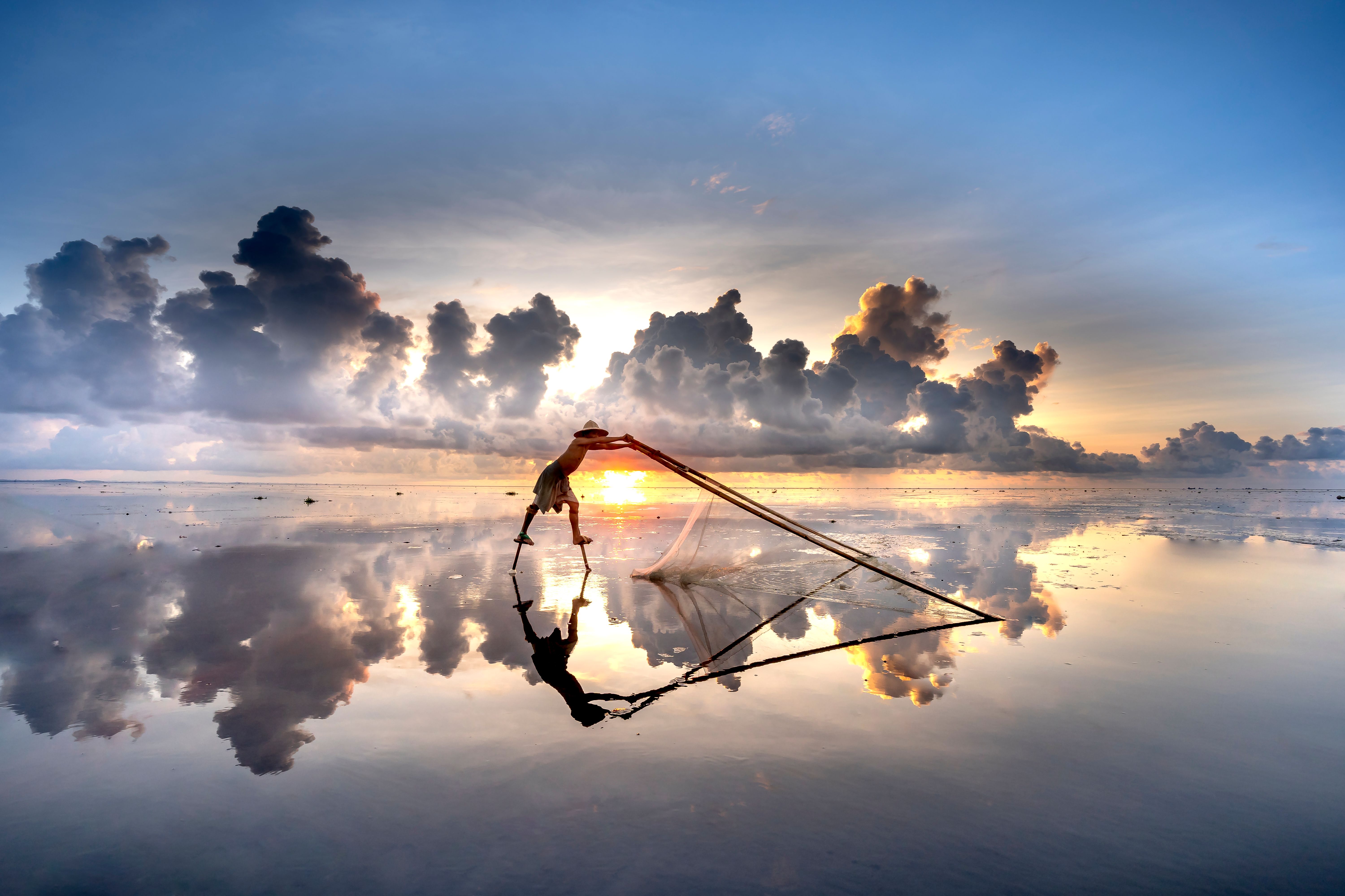 A Fisherman Fishing with a Fishnet · Free Stock Photo