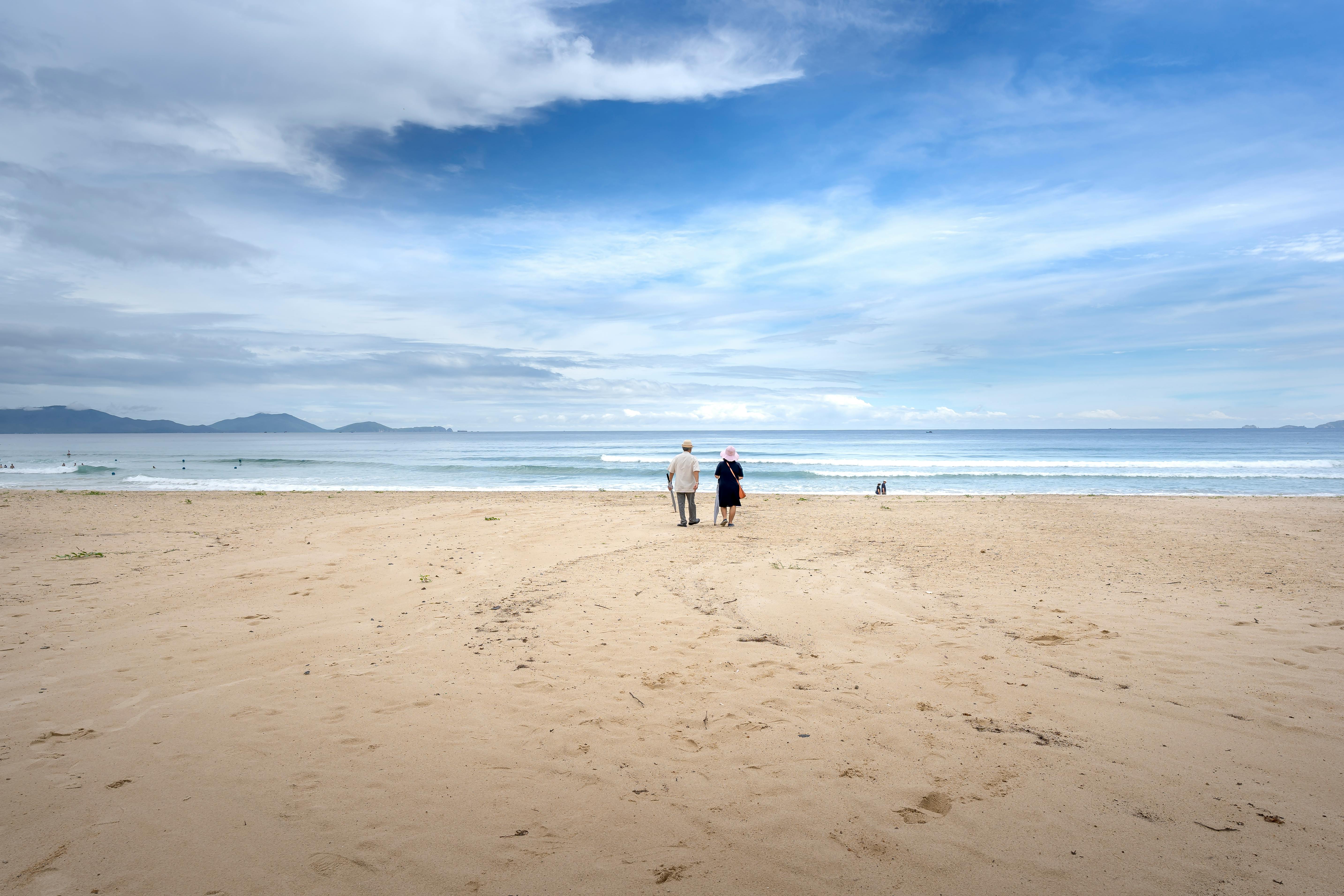 Person Walking on Beach · Free Stock Photo