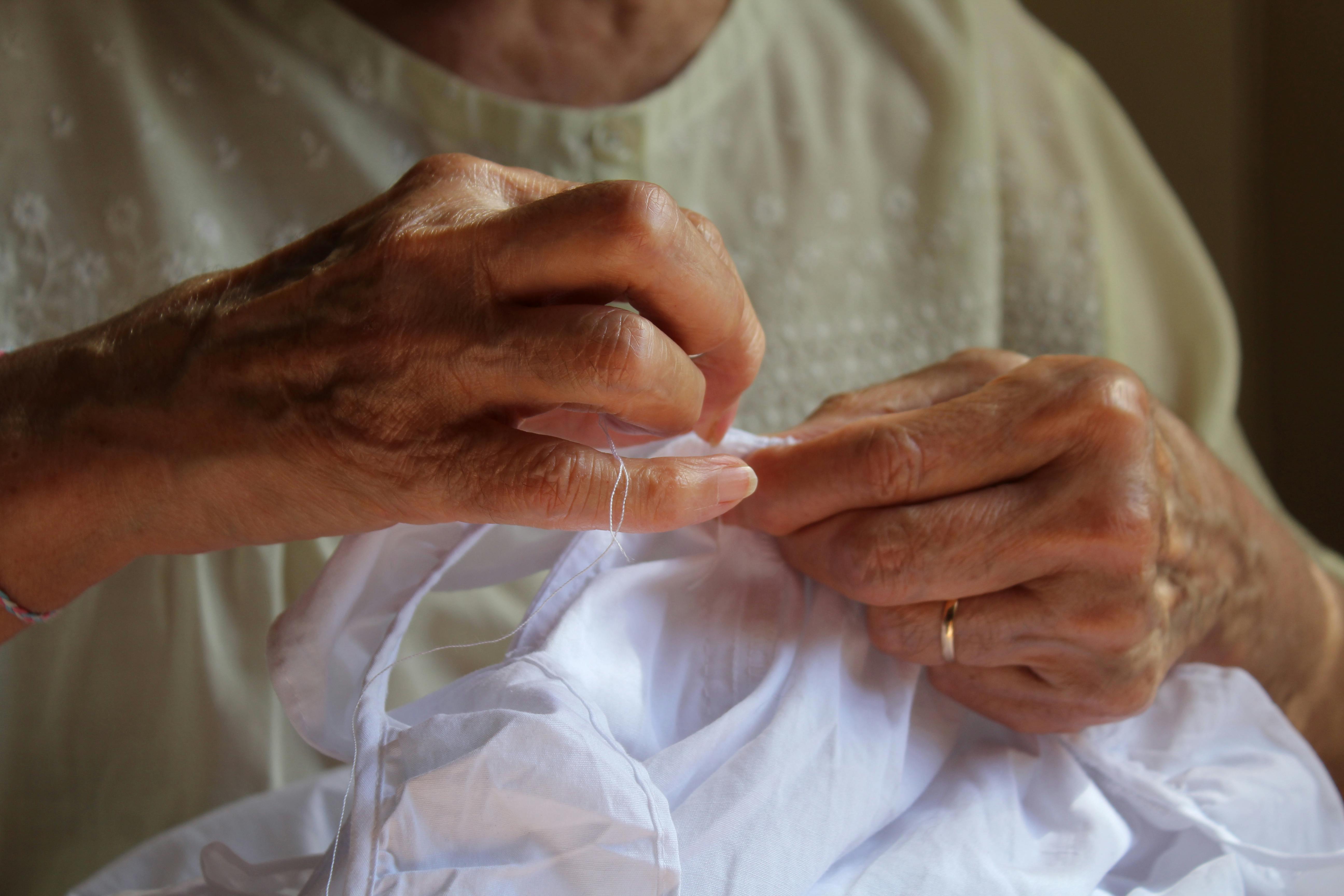 Photo of a Woman's Hands Sewing · Free Stock Photo