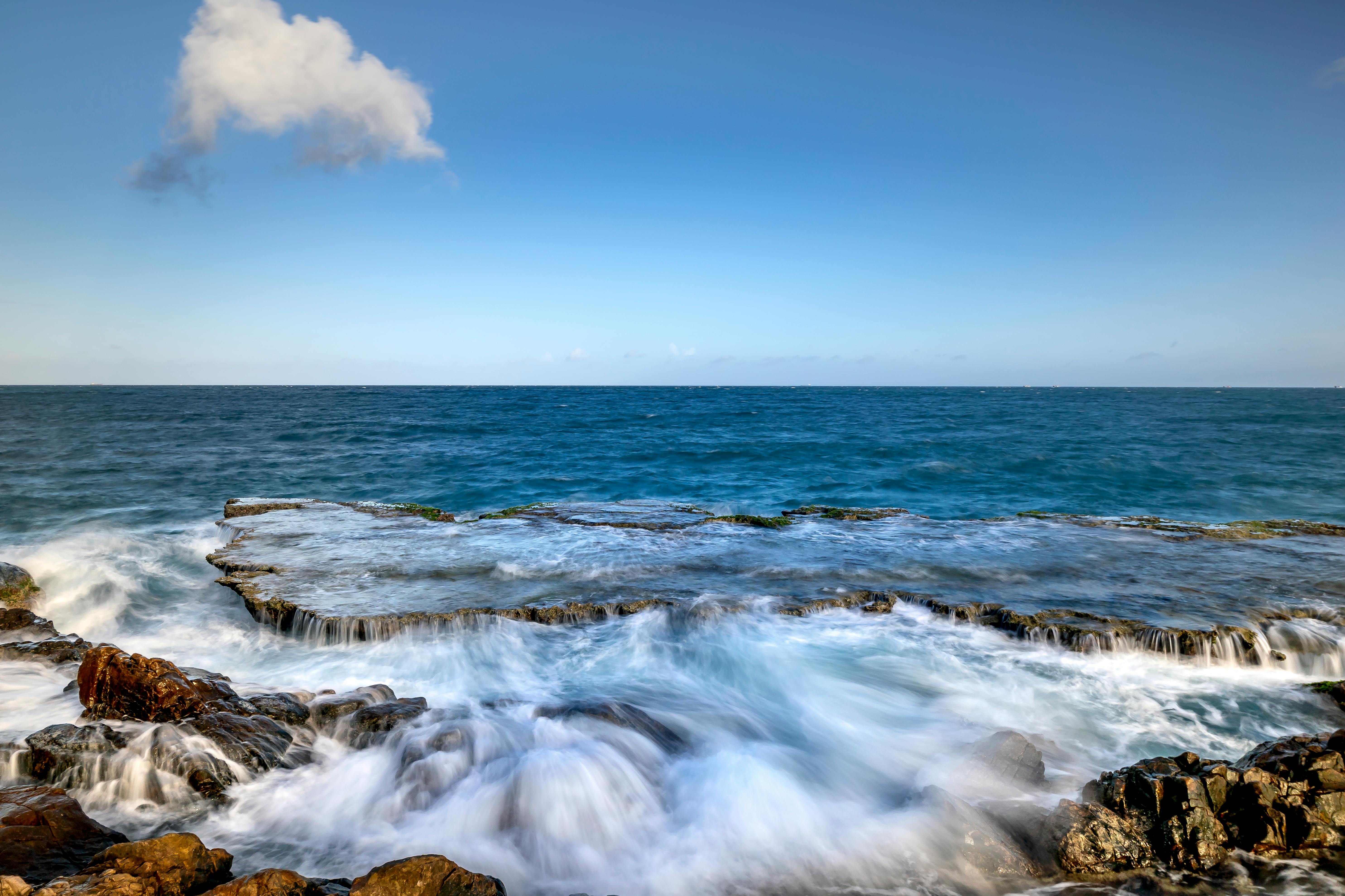 Blue Seascape with Waves on Rocks and Cloud in Sky · Free Stock Photo