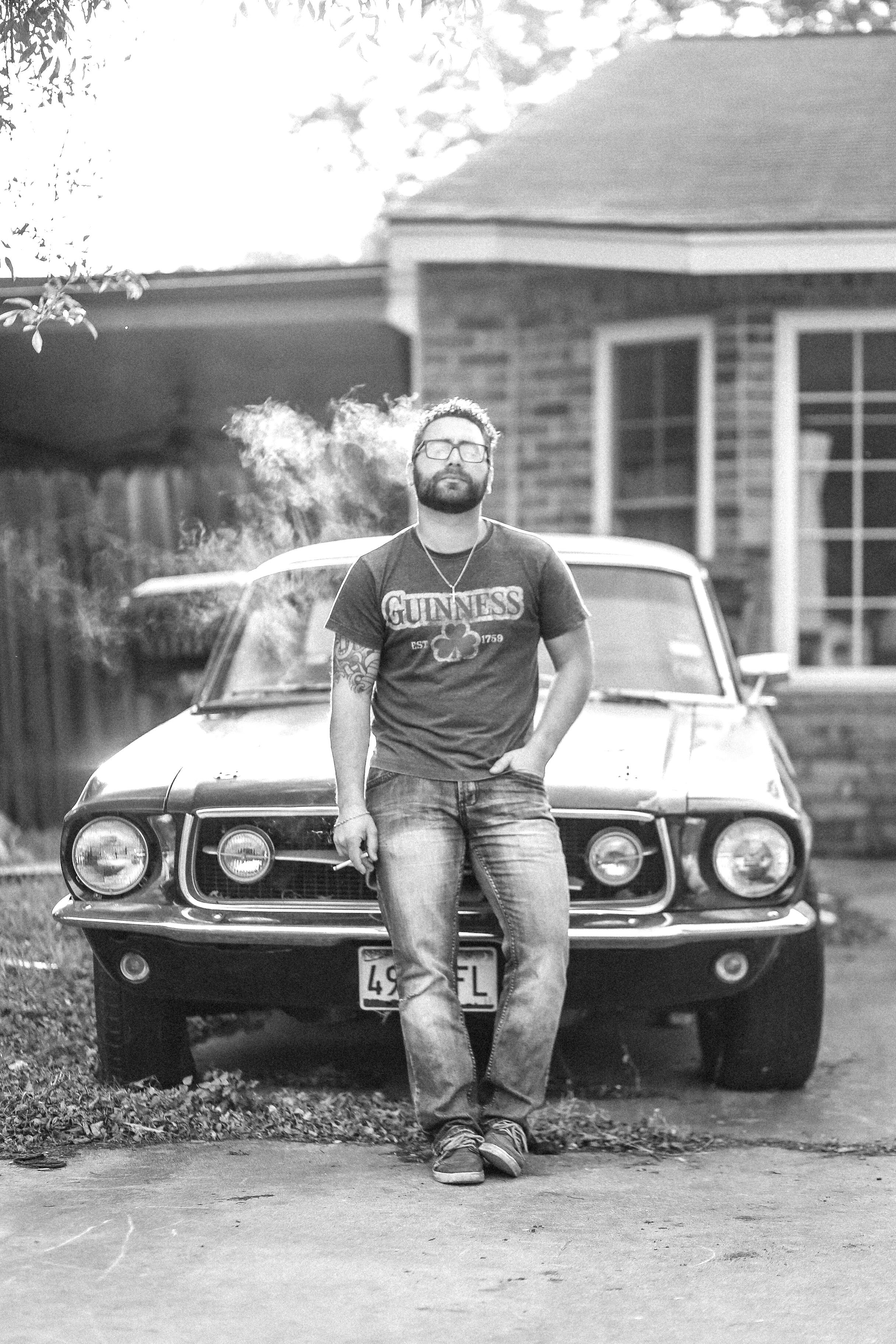 Grayscale Photography of Man Leaning Beside Car · Free Stock Photo