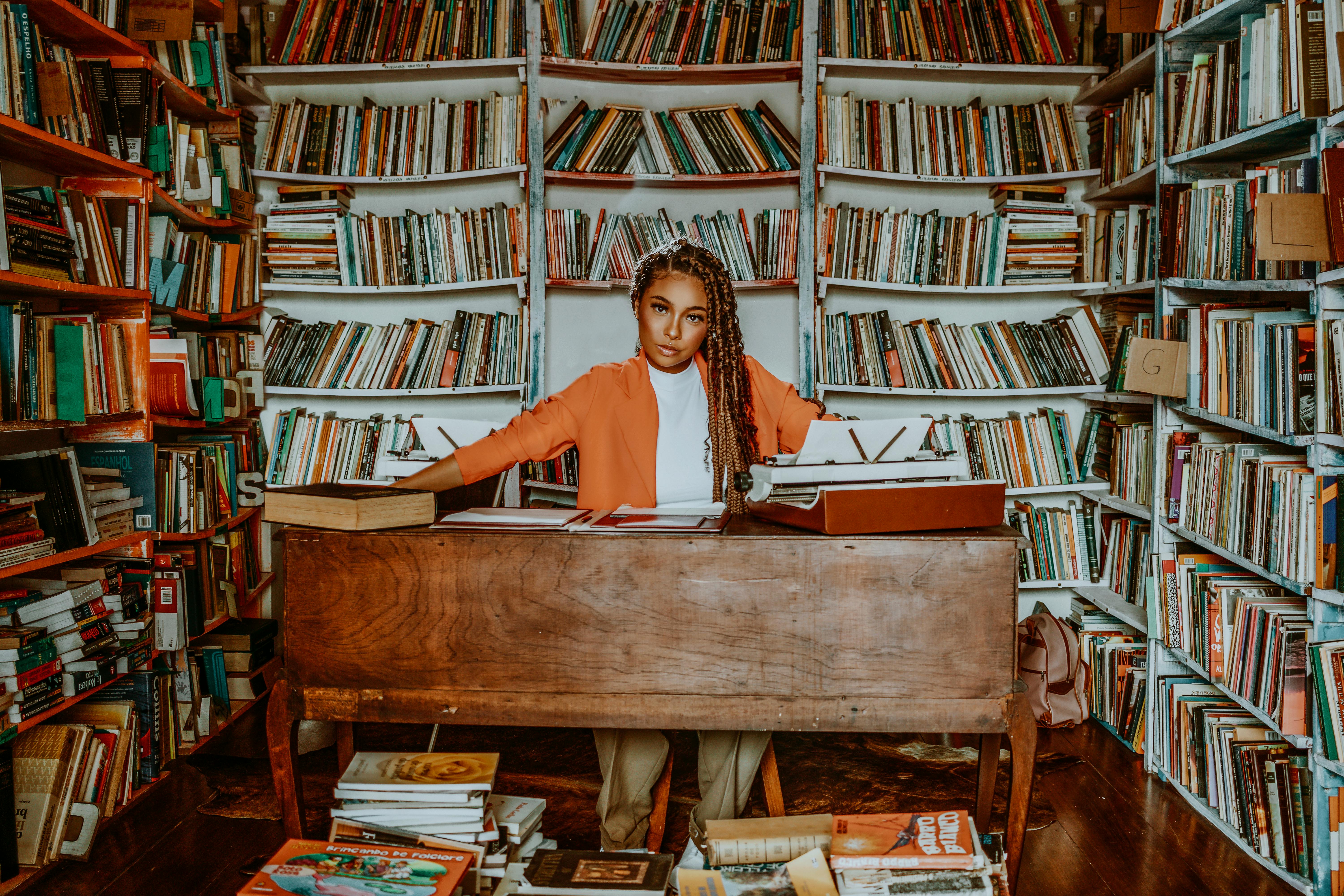 Woman Peaking Through Books · Free Stock Photo